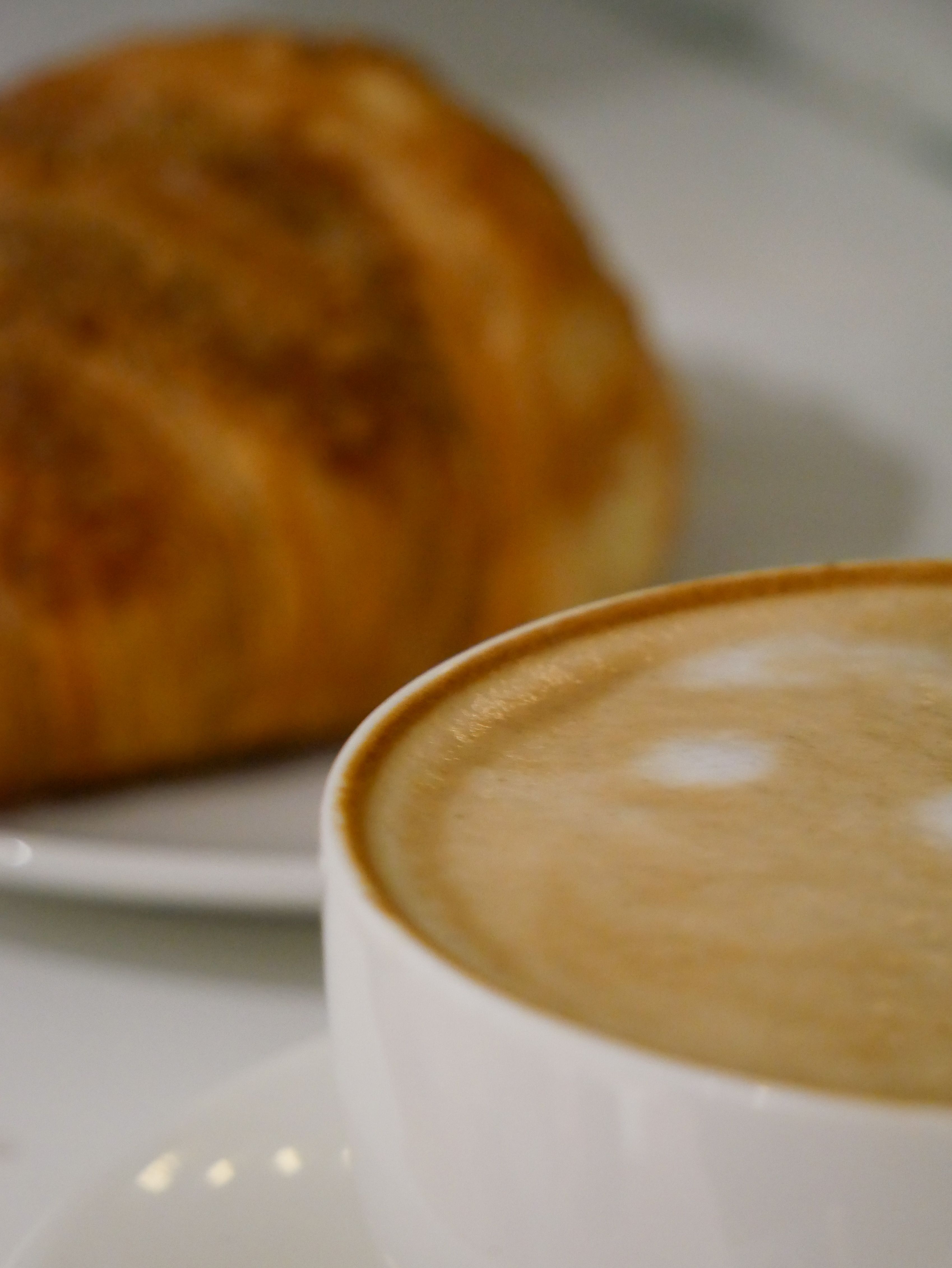 Cappuccino Against Pastry on Plate · Free Stock Photo