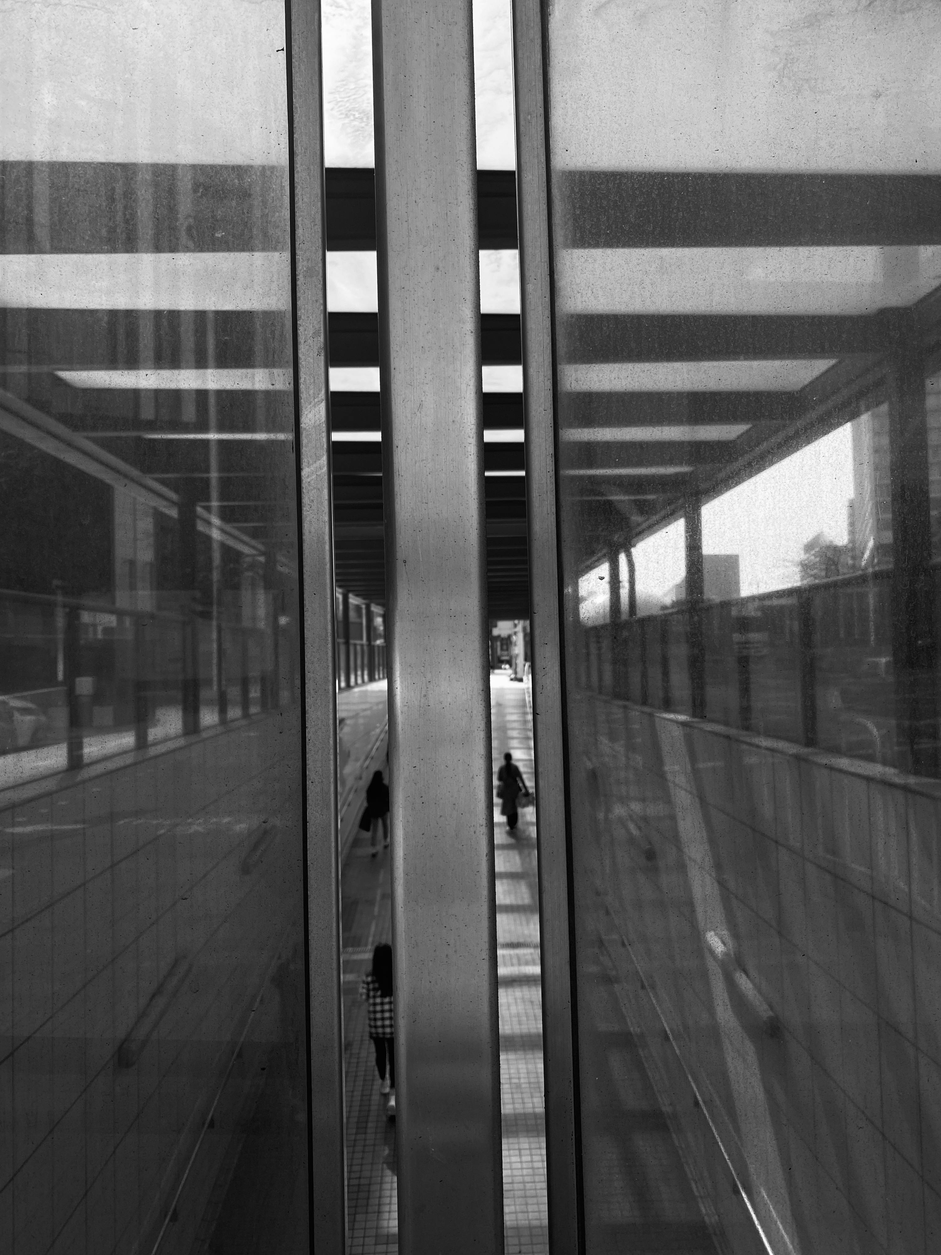 Walking People behind Gaps between Windows and Post · Free Stock Photo