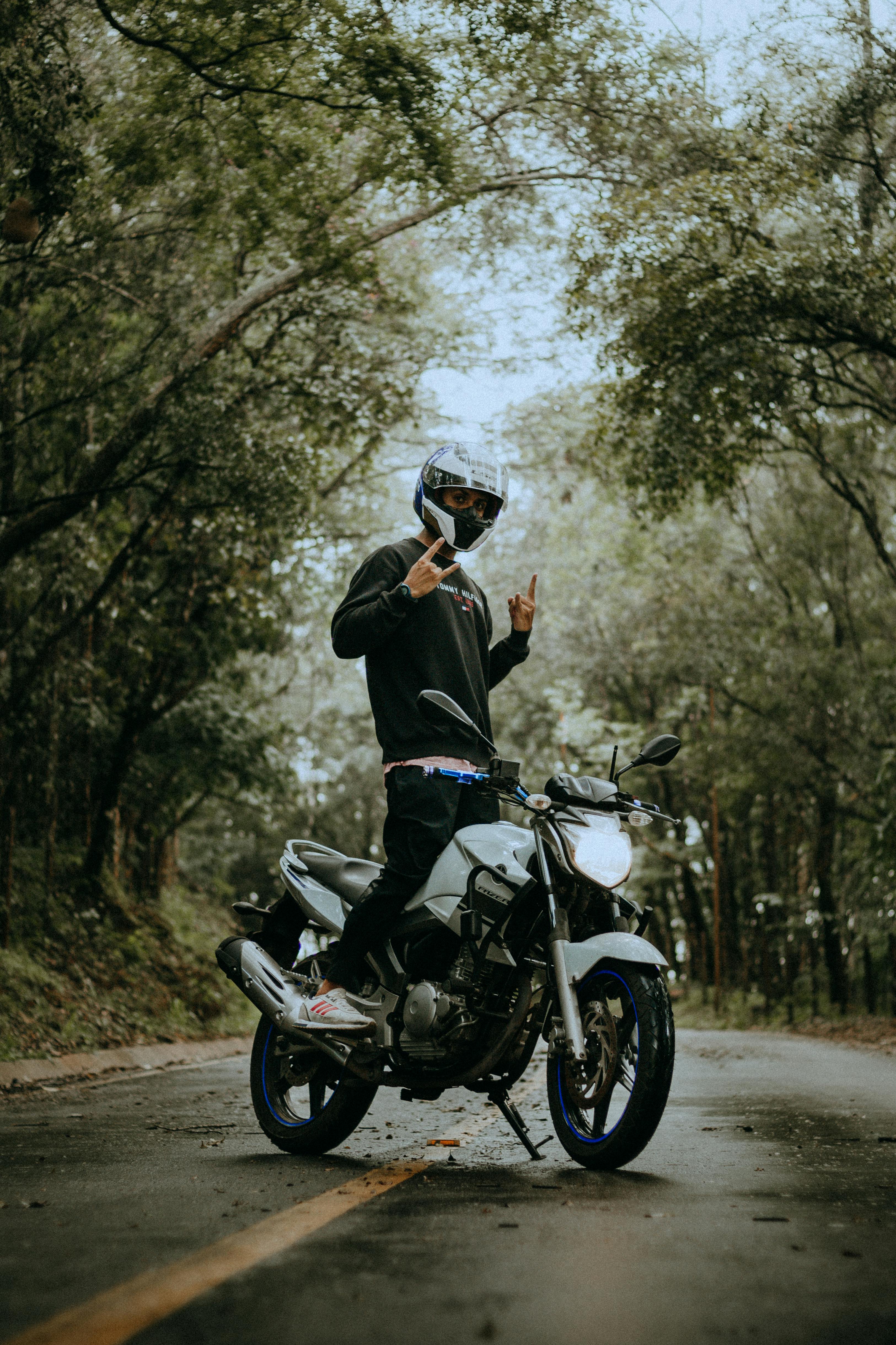 Young Man Posing on a Motorcycle Standing in the Middle of a Forest ...