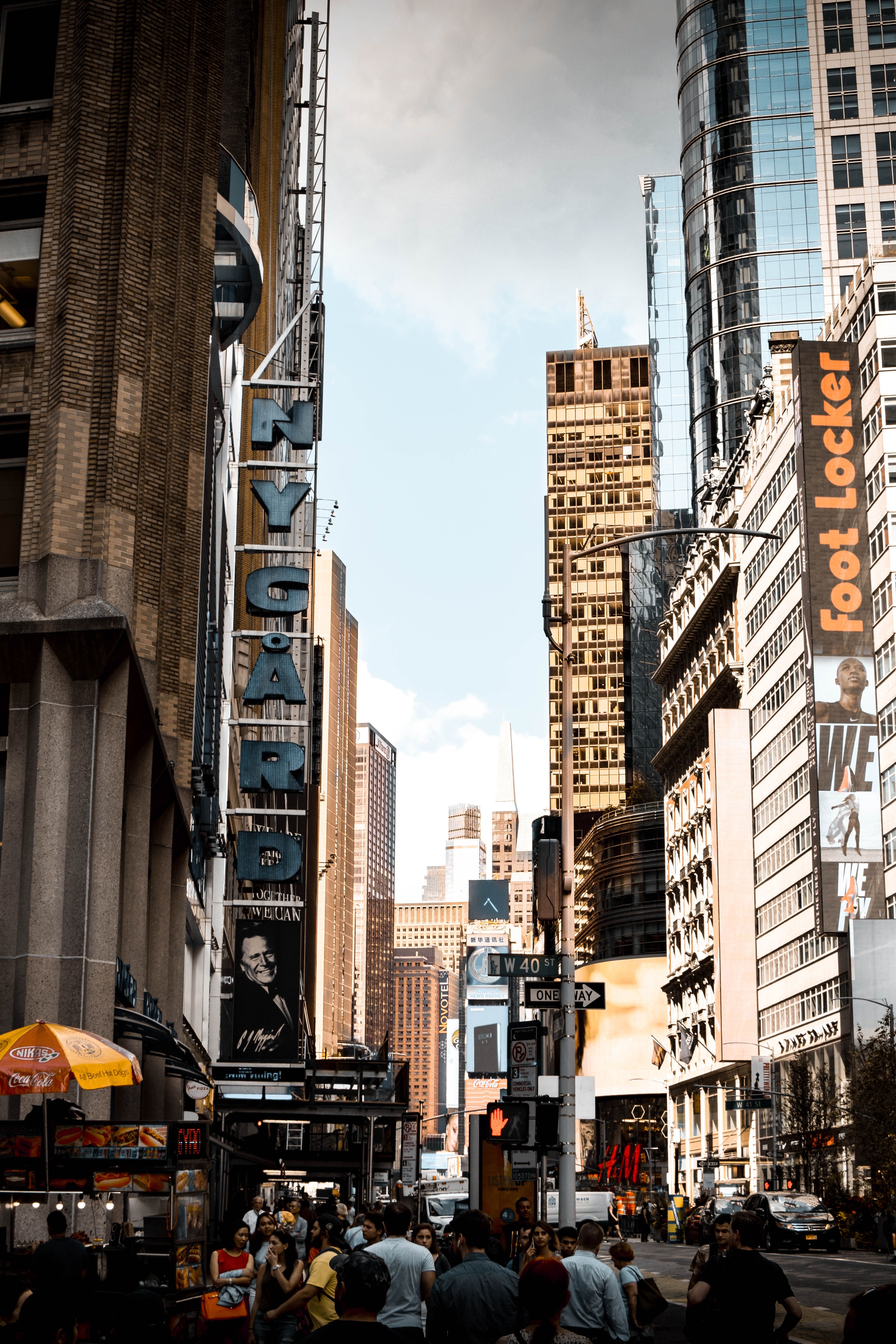 People Passing By Buildings Free Stock Photo