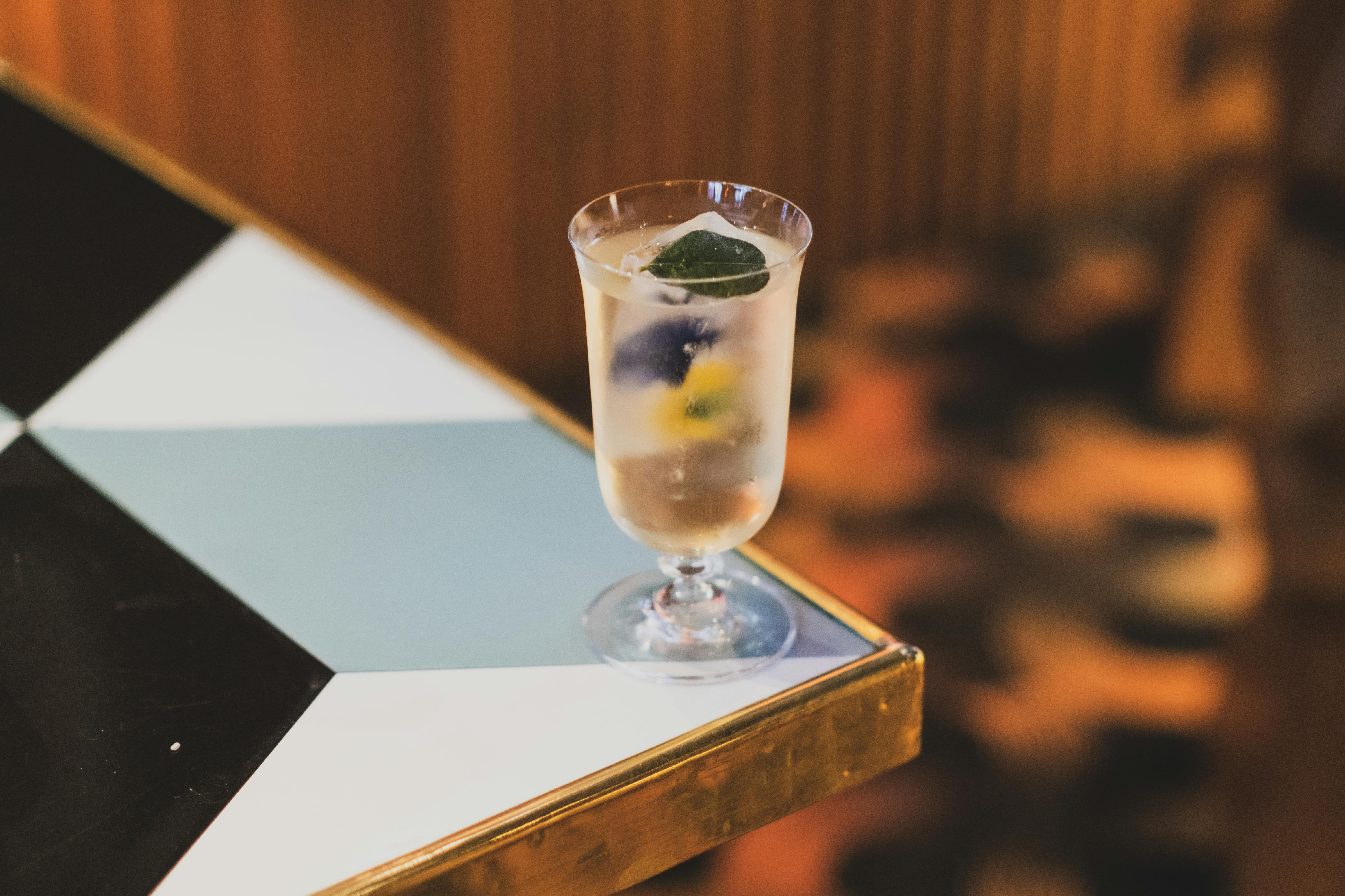 A Cocktail Standing on the Edge of a Table in a Bar · Free Stock Photo