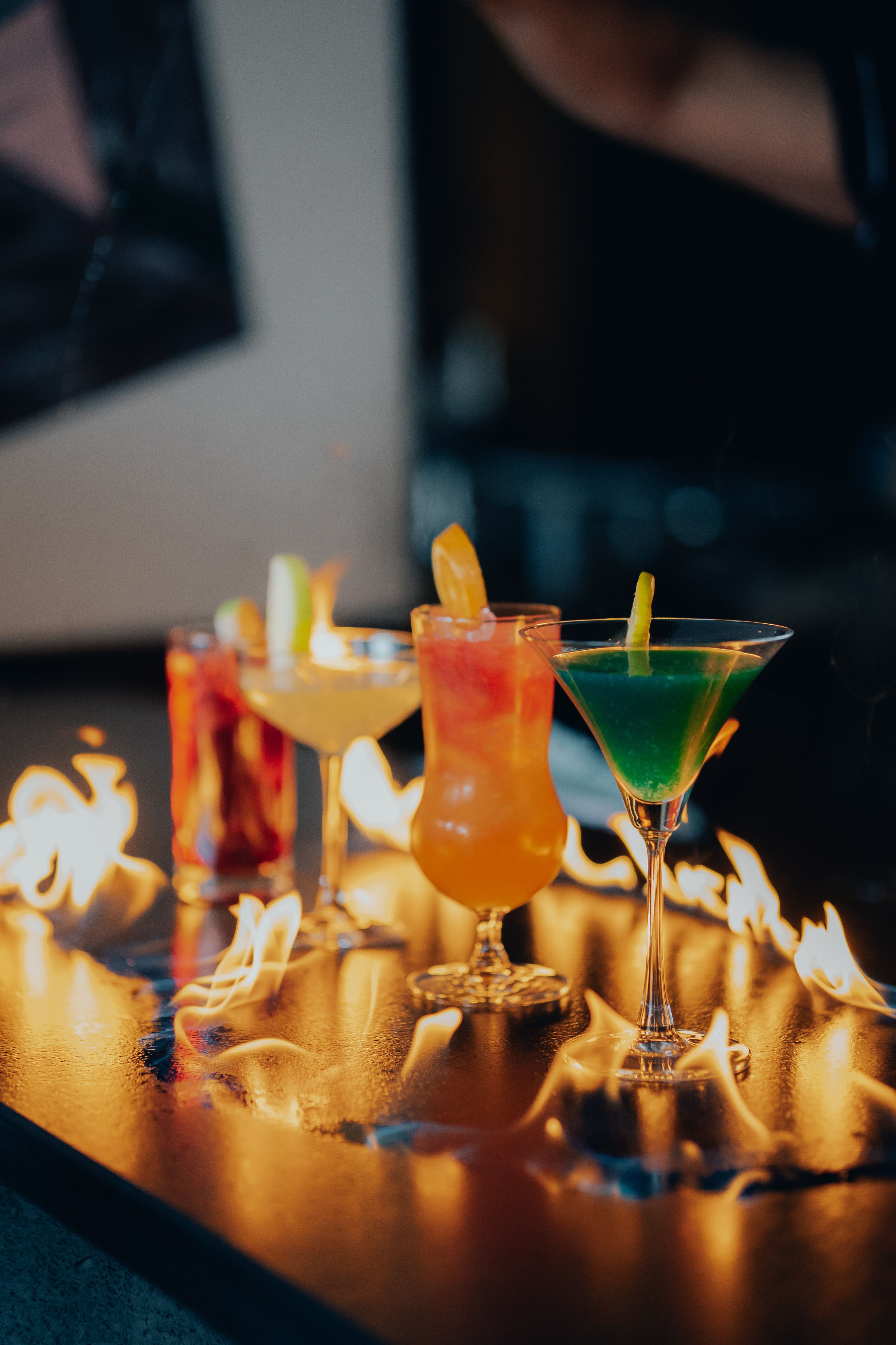 Colorful Cocktails Standing in Line on Bar Counter · Free Stock Photo
