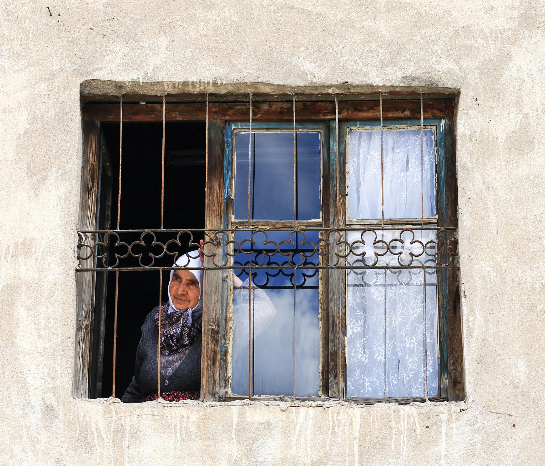 A Woman in a Window · Free Stock Photo