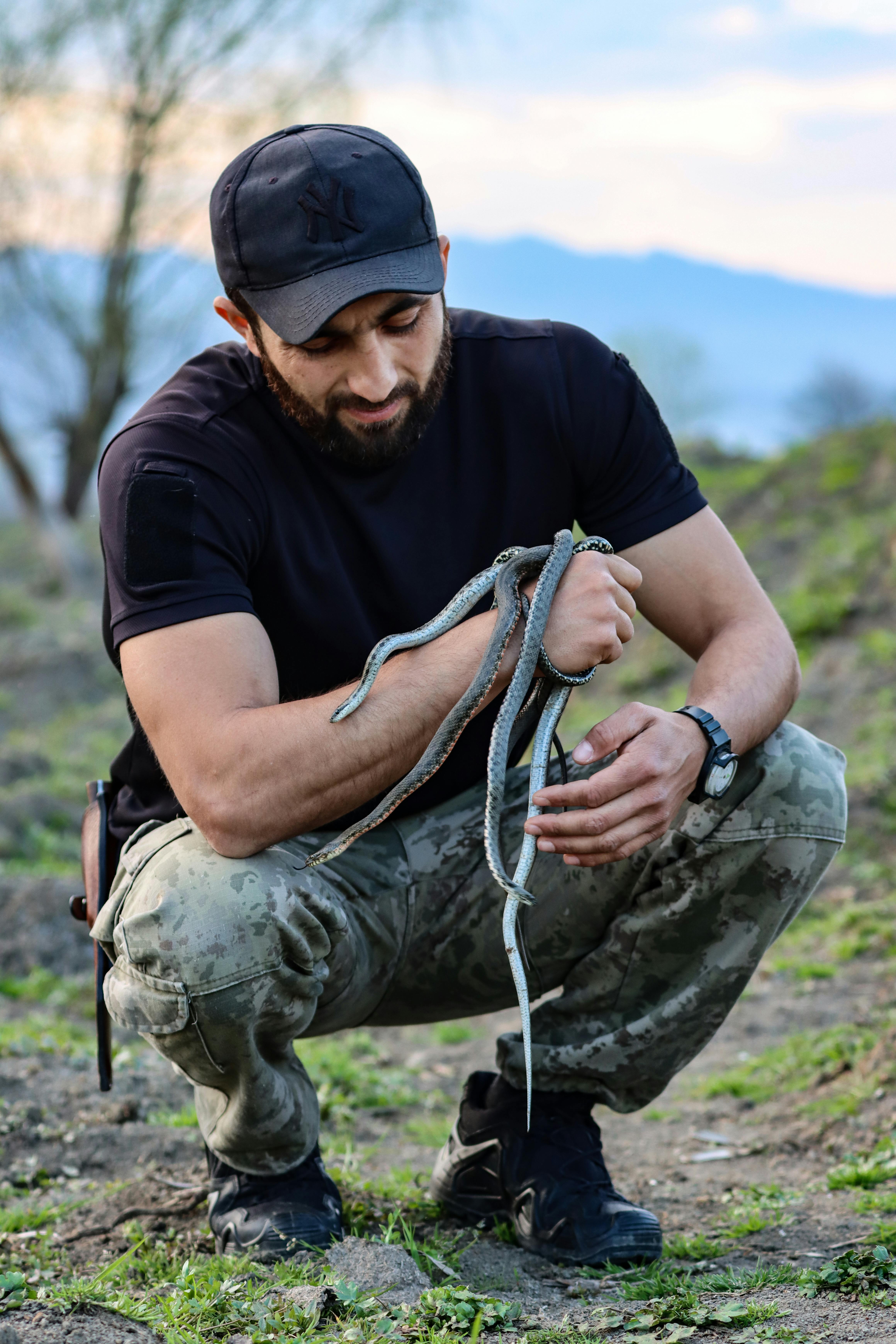 Man Holding Snakes · Free Stock Photo