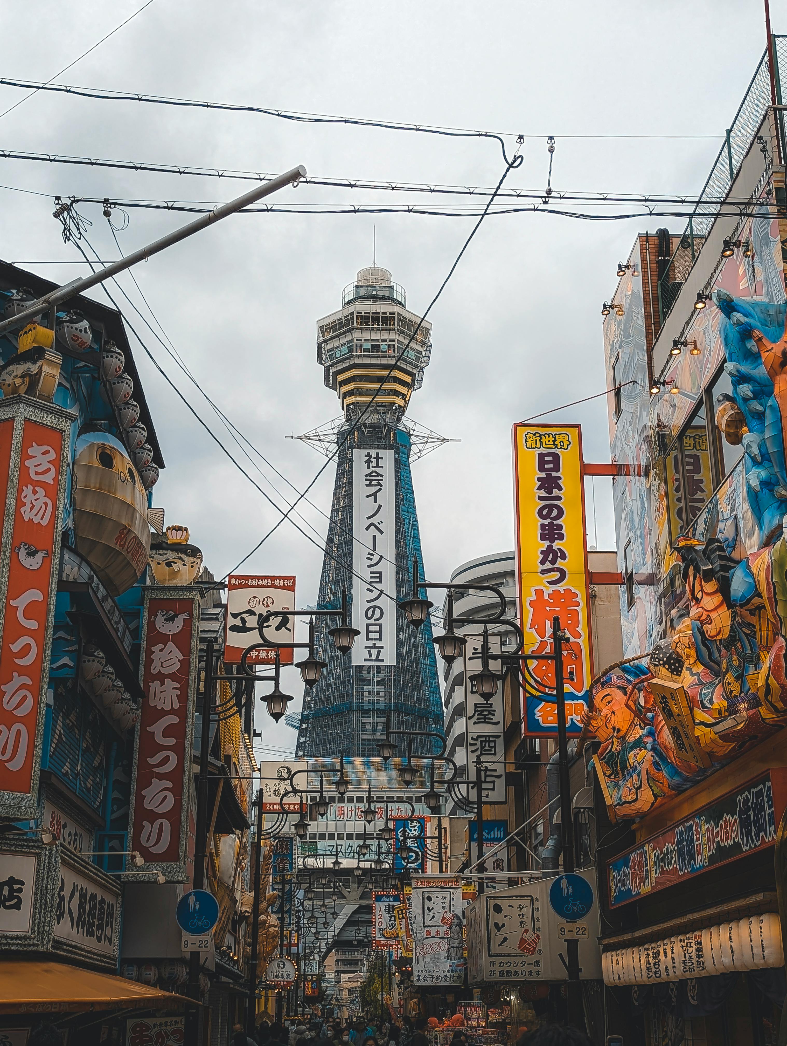 A Busy City Street with the View of Tsutenkaku in Osaka, Japan · Free ...