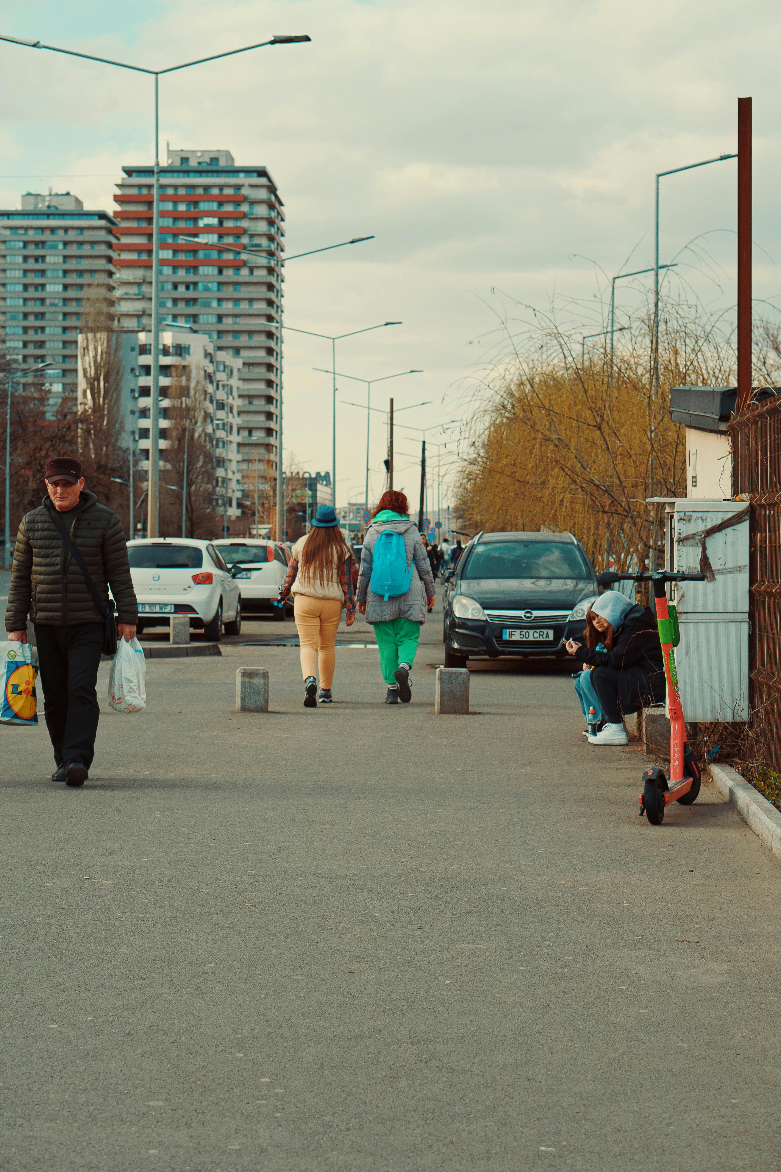 People Walking on a Pavement in a Residential District with Blocks of ...