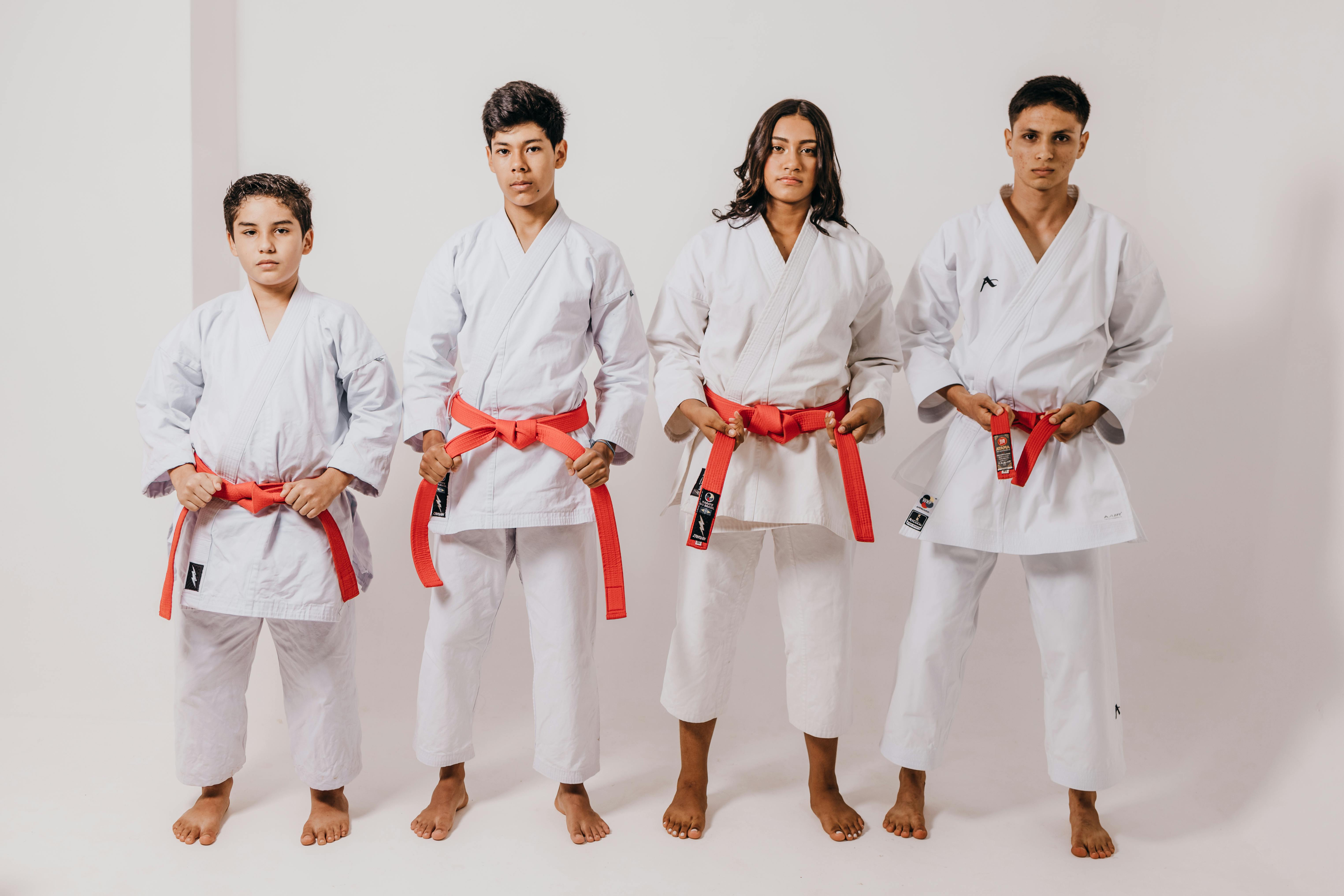 Group of Karate Students Tying Their Belts · Free Stock Photo