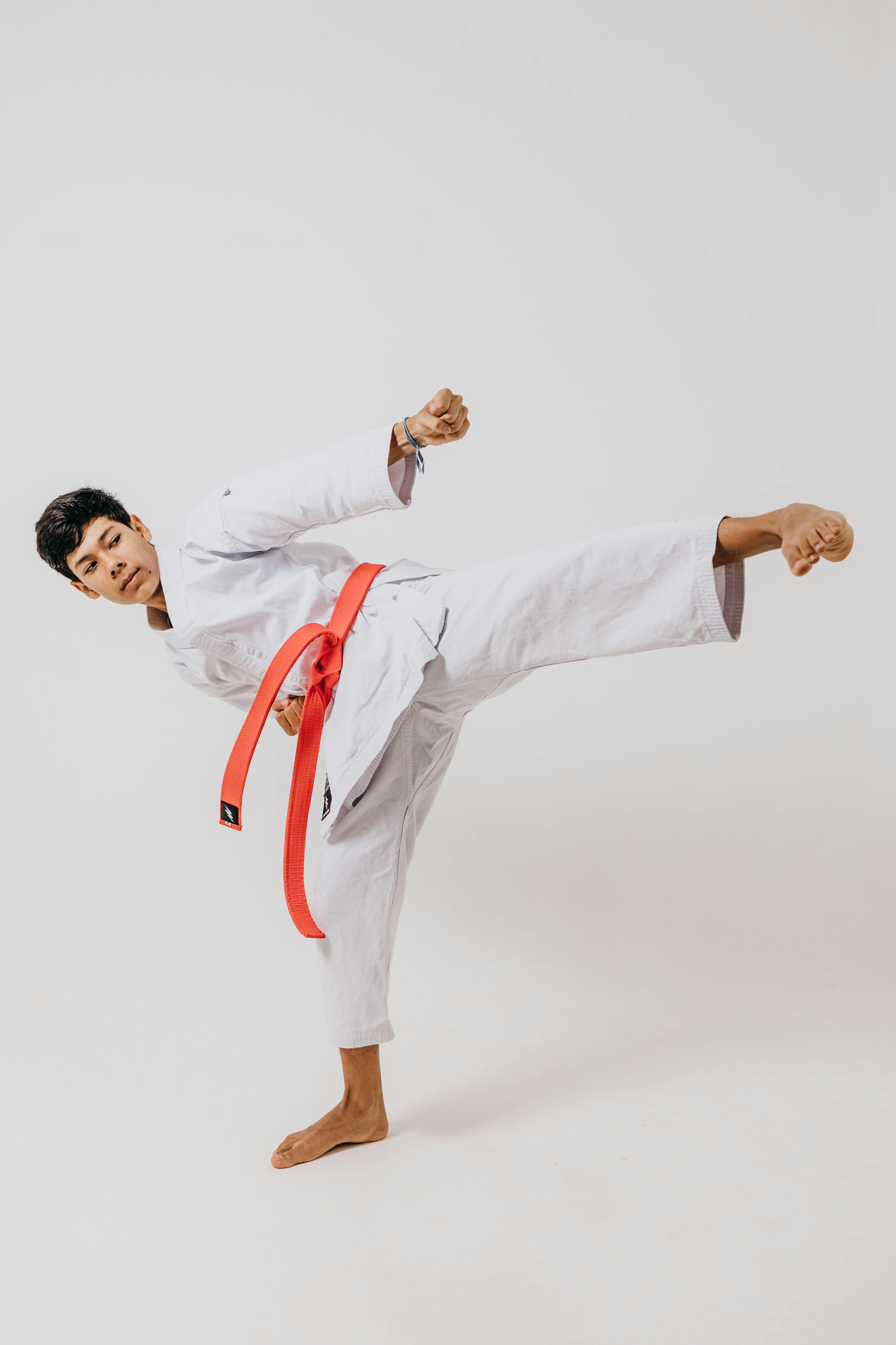Boy in Kimono Doing a Kick · Free Stock Photo
