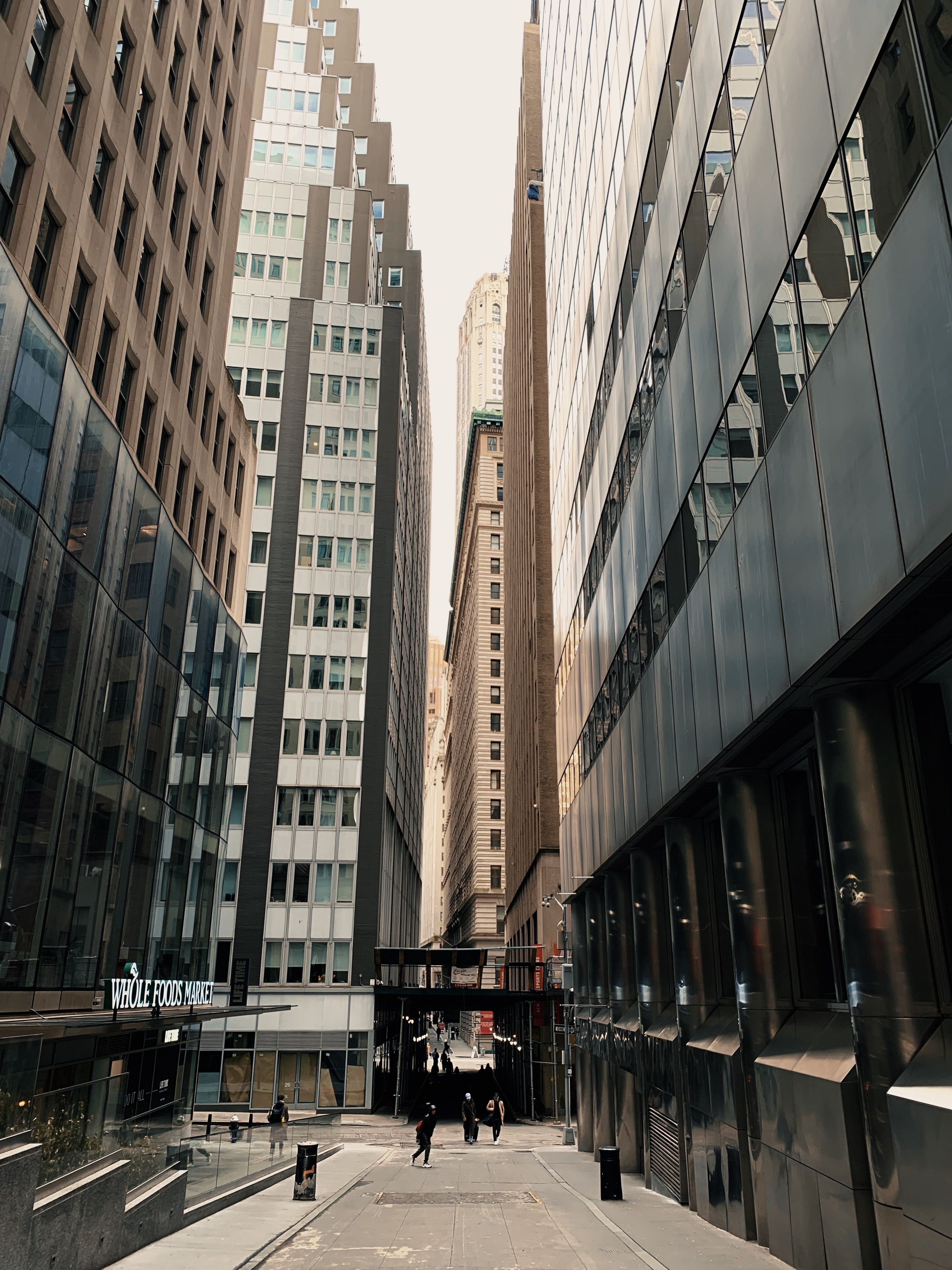 People Walking on the Street Between Buildings · Free Stock Photo