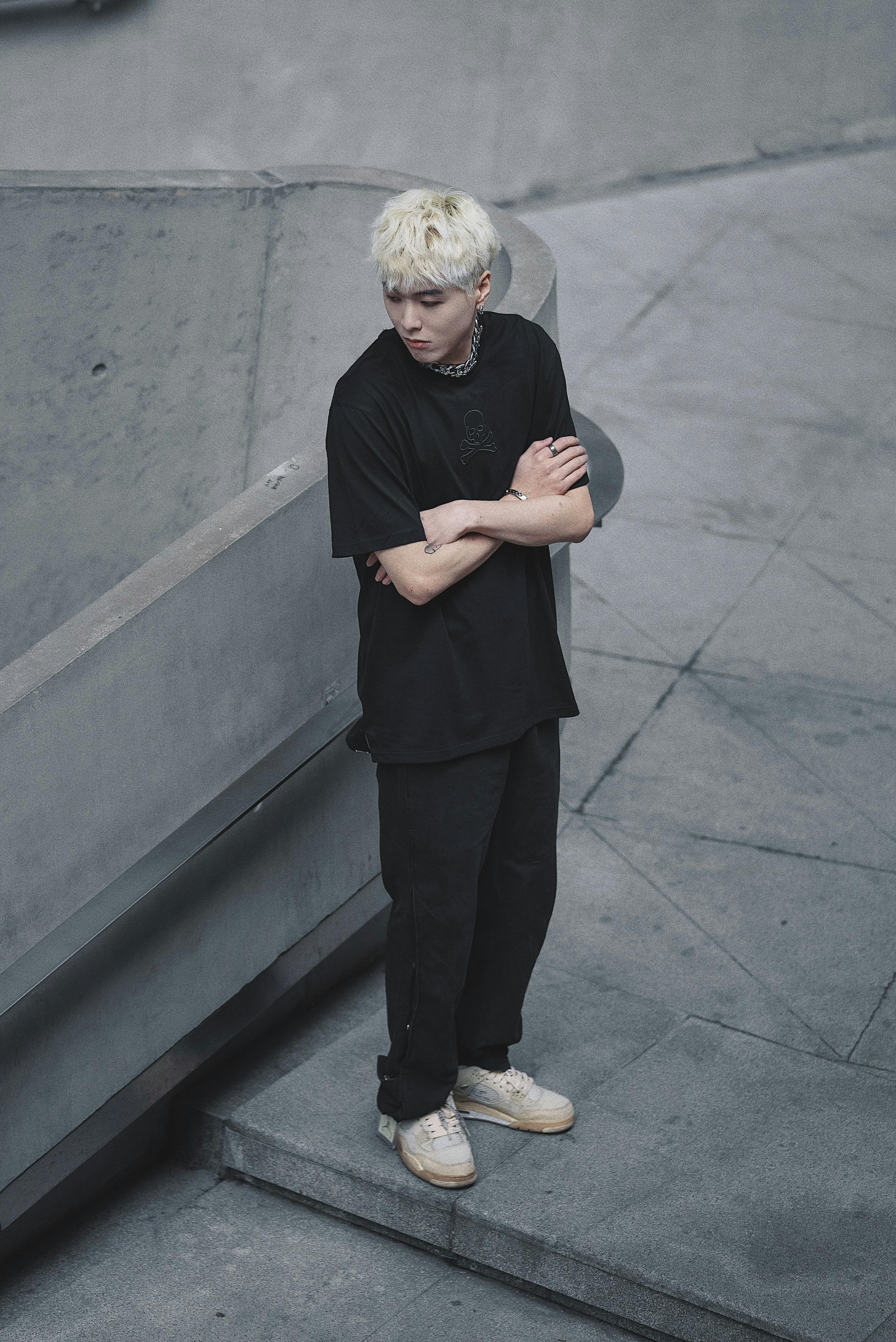 Young Man with Bleached Hair in a Casual Black Outfit · Free Stock Photo