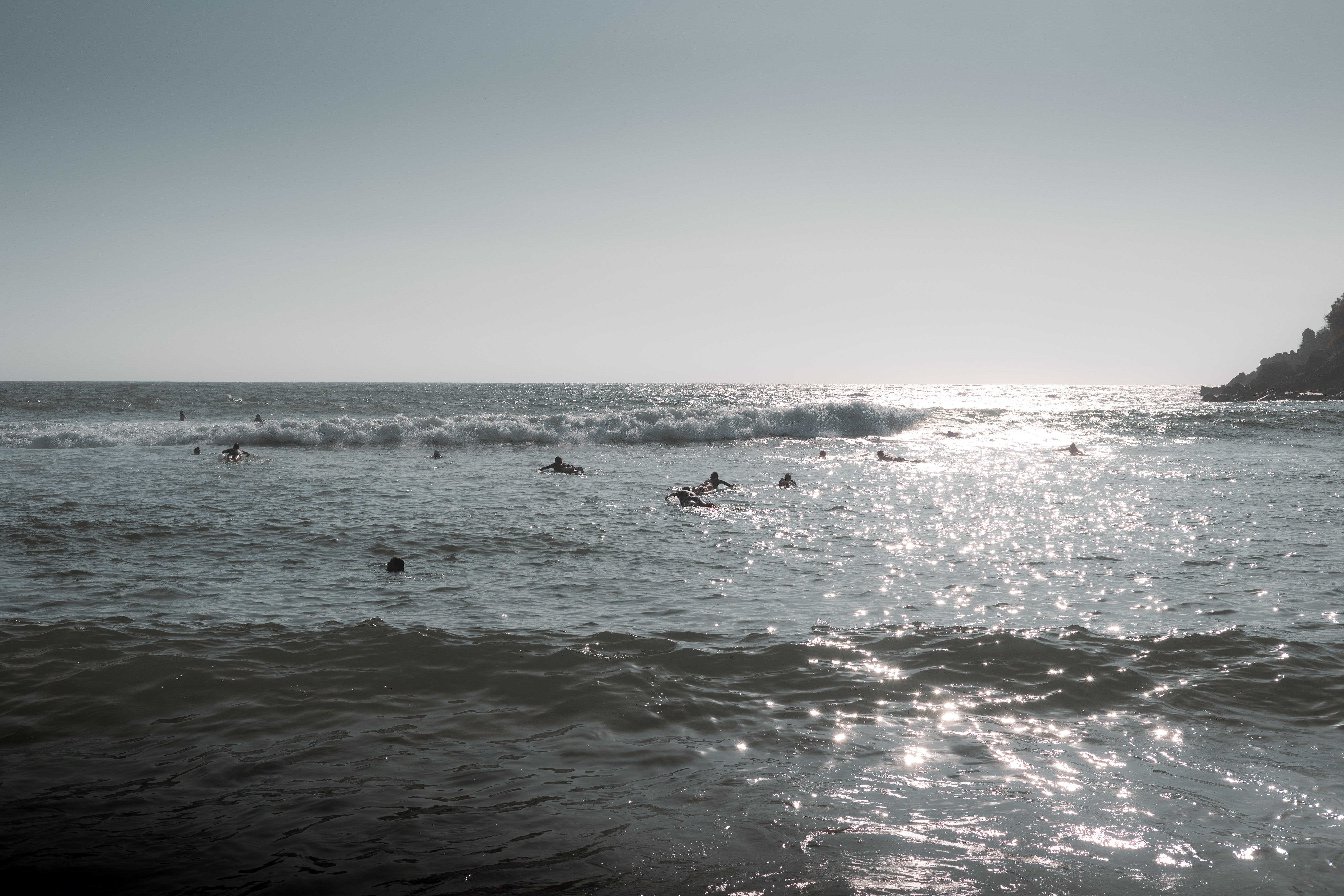 A group of people swimming in the ocean · Free Stock Photo