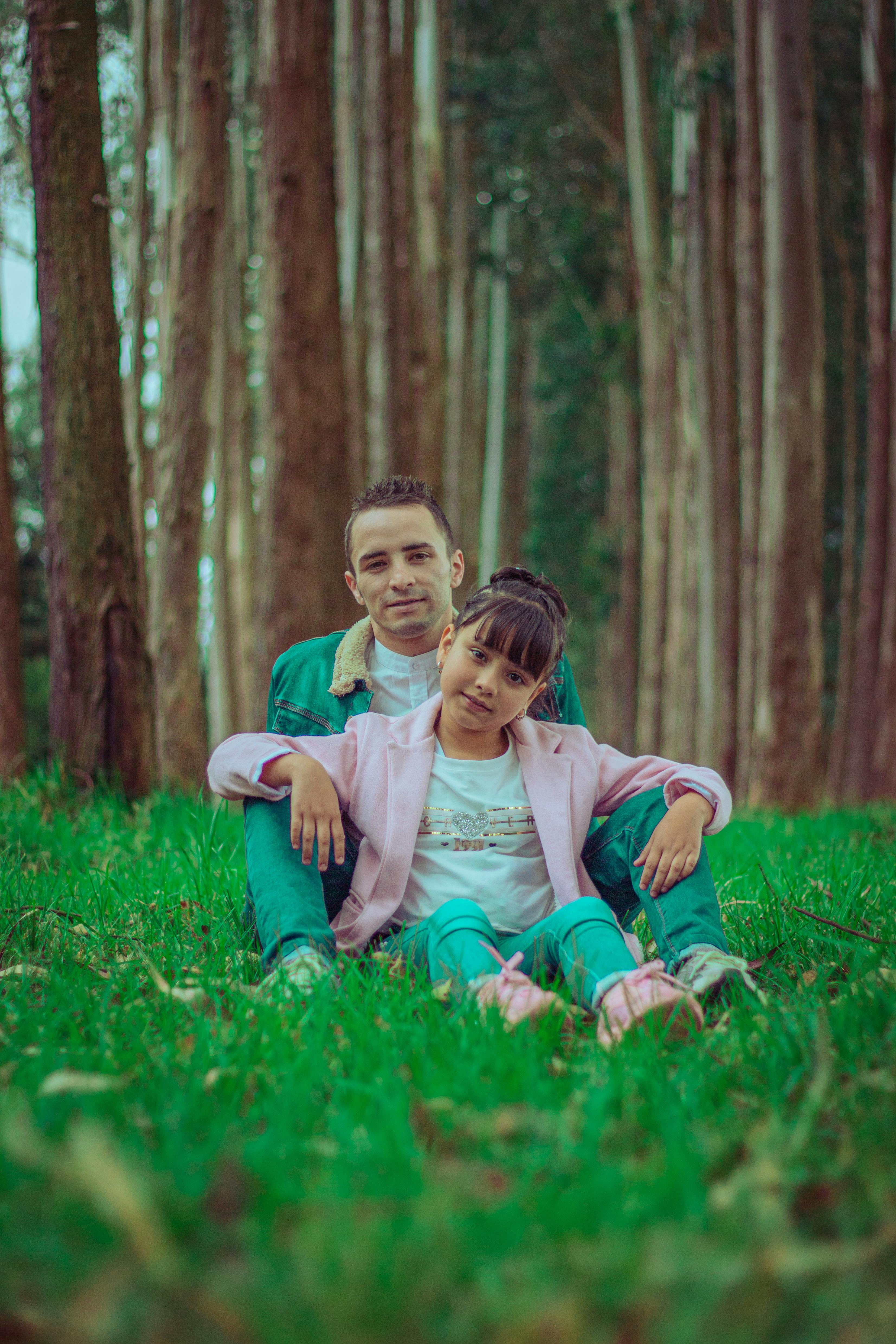 Father Sitting in Forest with Daughter · Free Stock Photo
