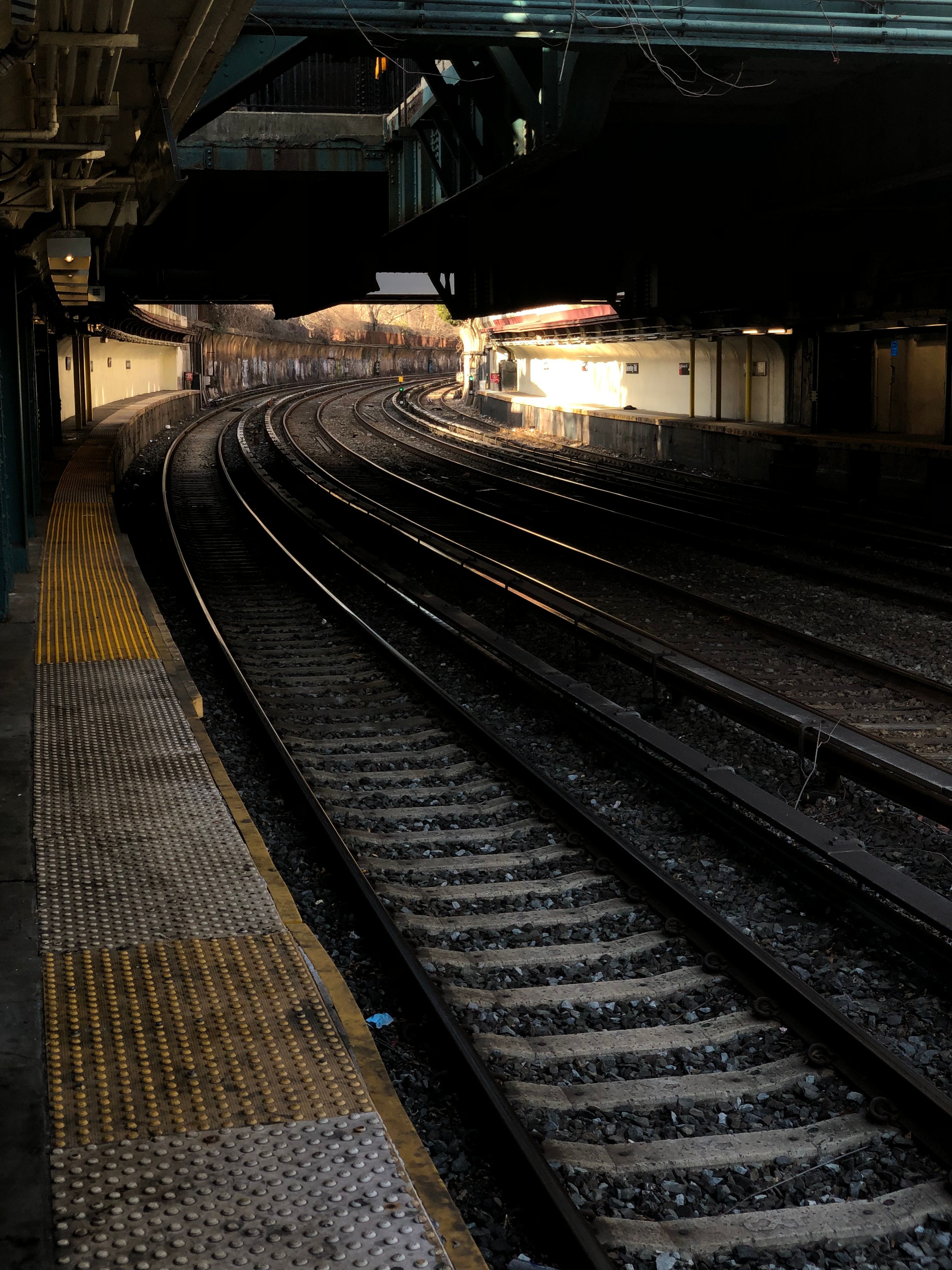 Black Outdoor Pedestal Lamp Near Coaster Train Rail · Free Stock Photo