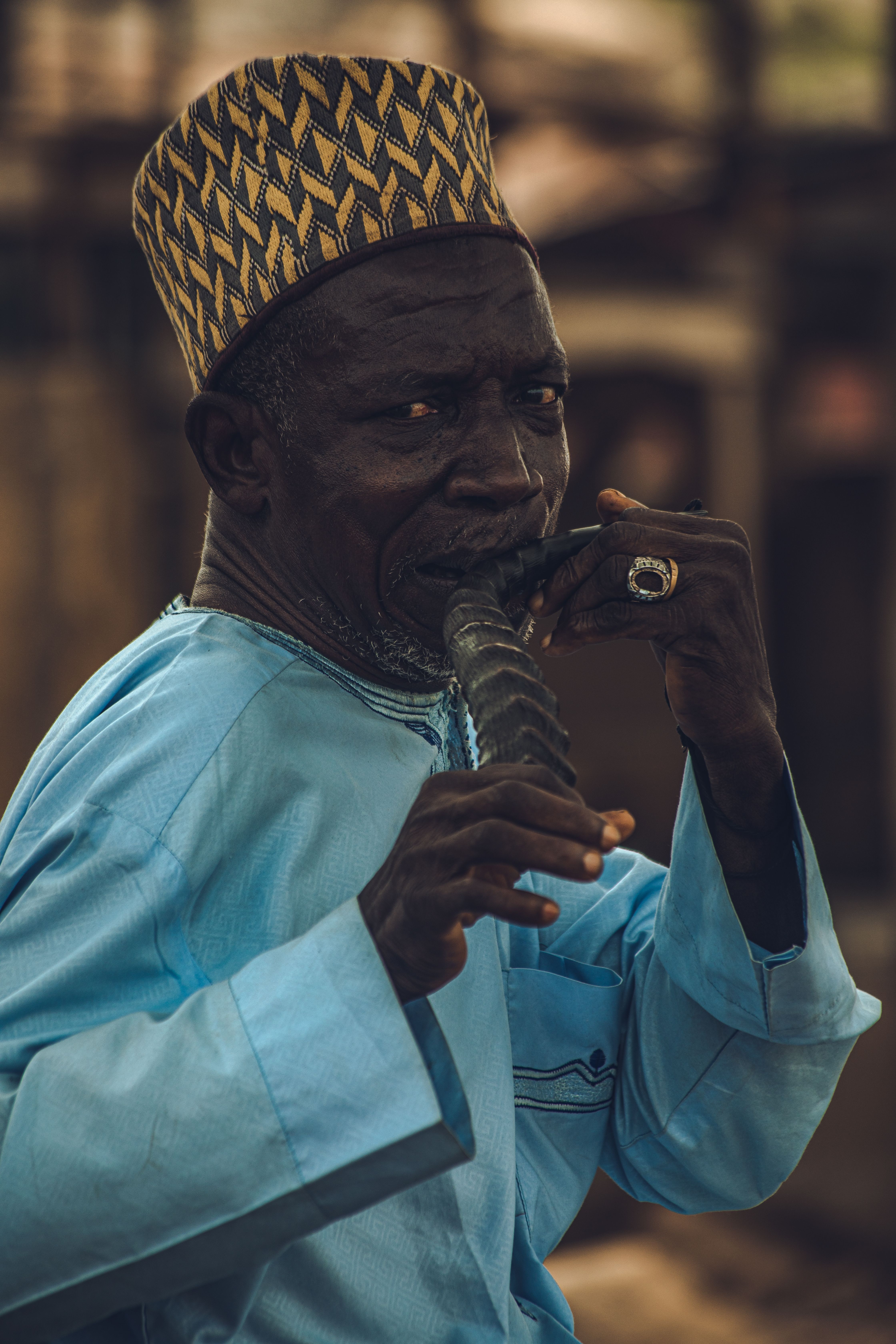 Man in Traditional Clothing Playing an Instrument · Free Stock Photo