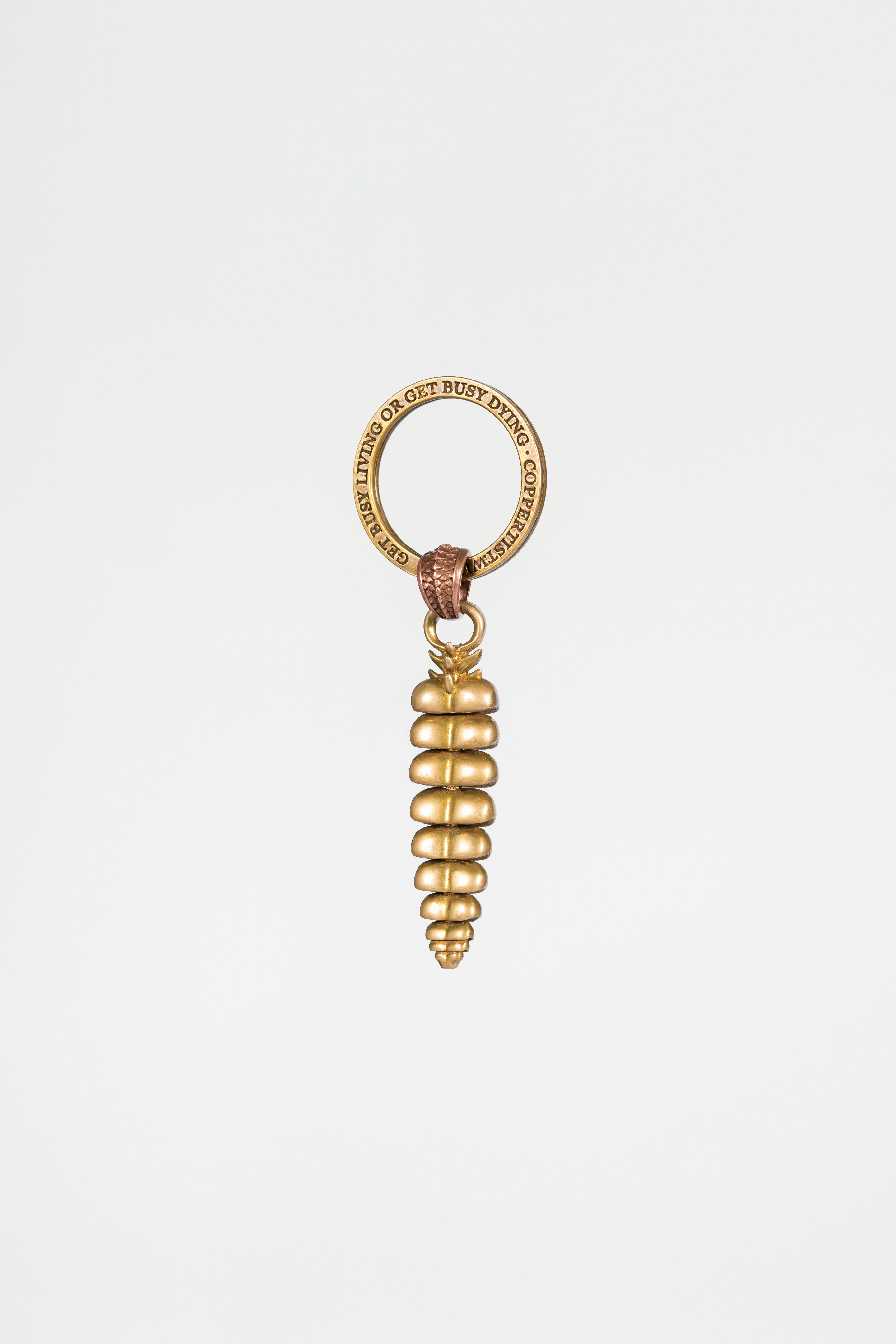 Golden Keychain on White Background · Free Stock Photo