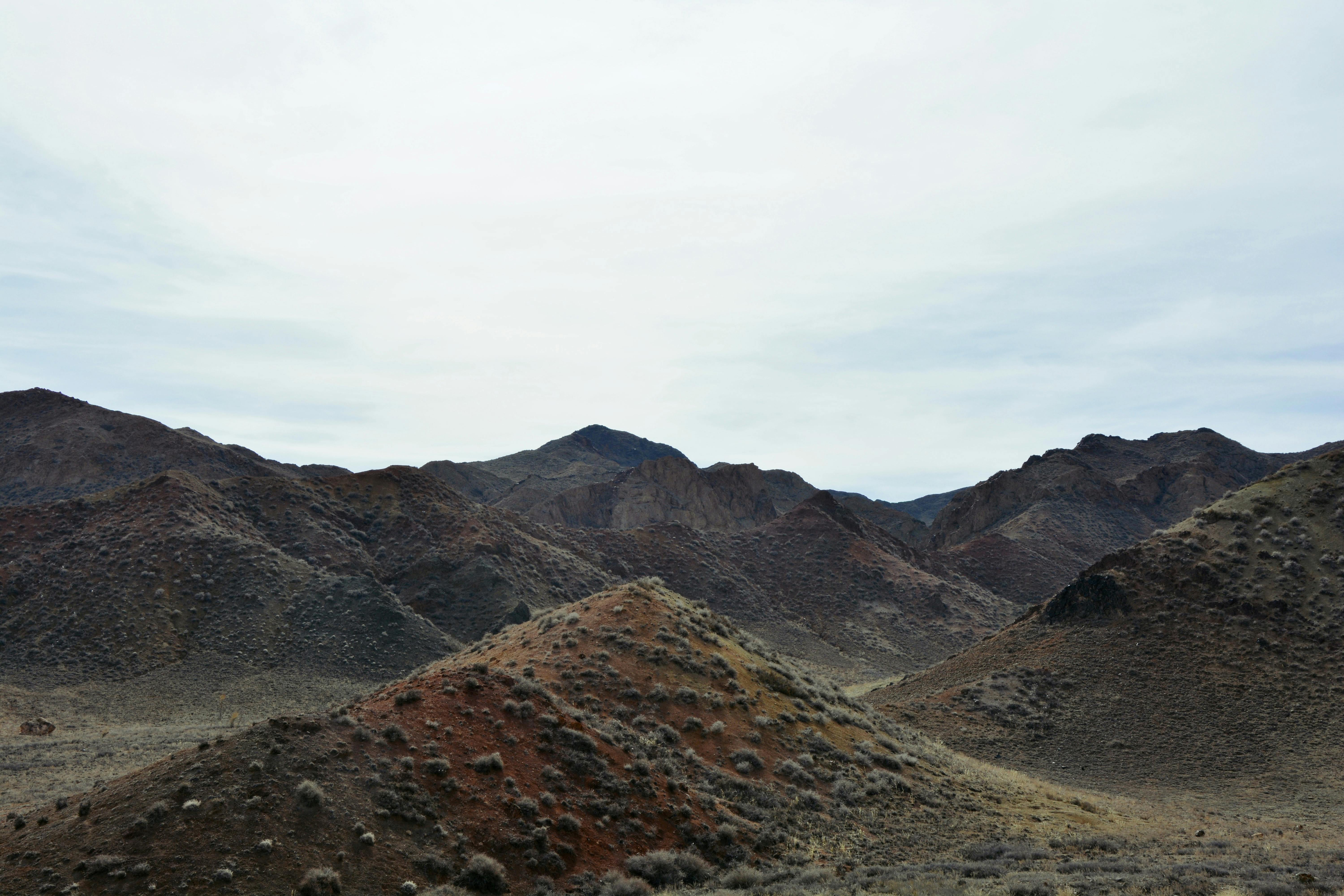 The desert is covered in brown and red rocks · Free Stock Photo