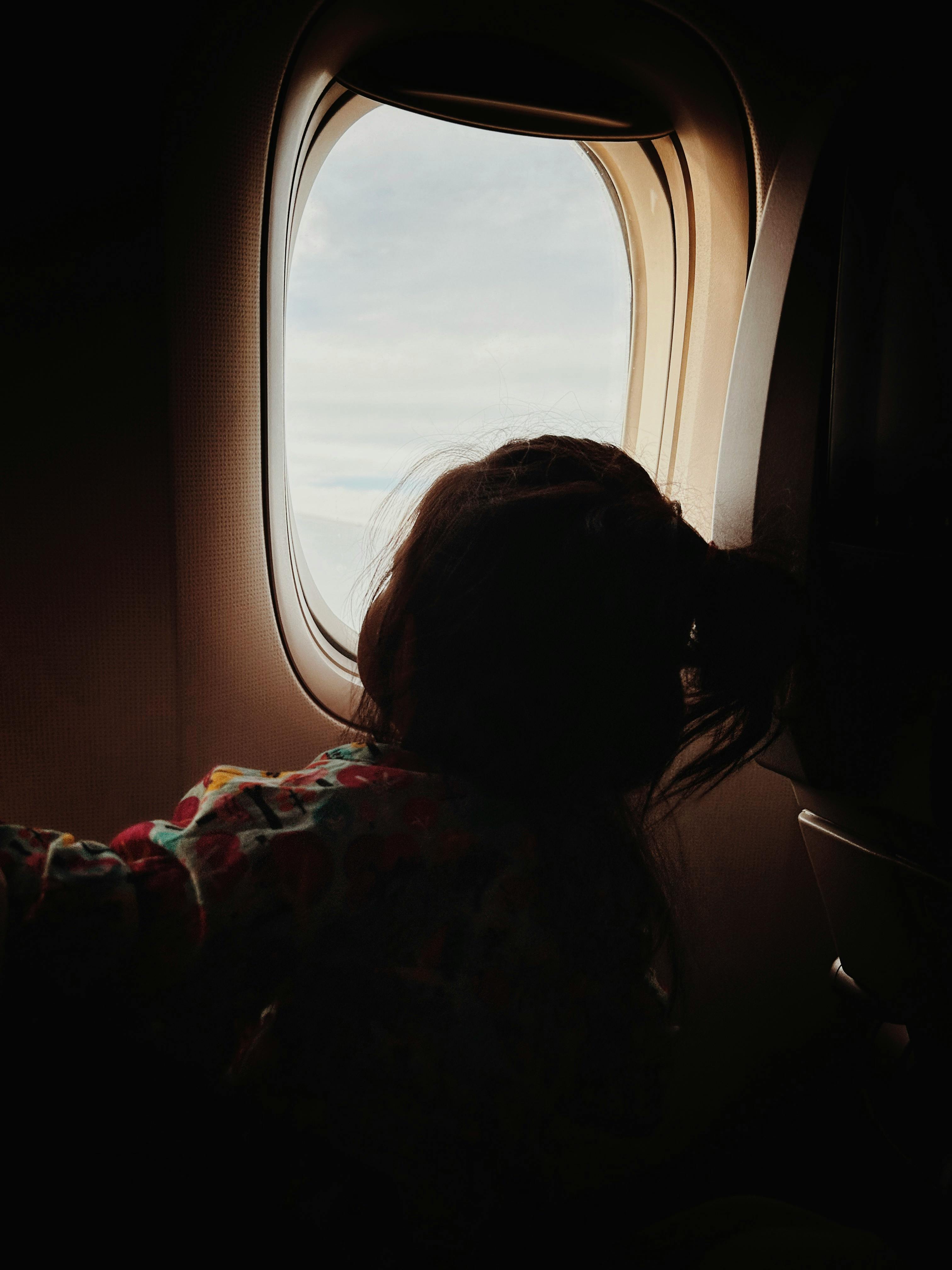Hand By Airplane Window · Free Stock Photo