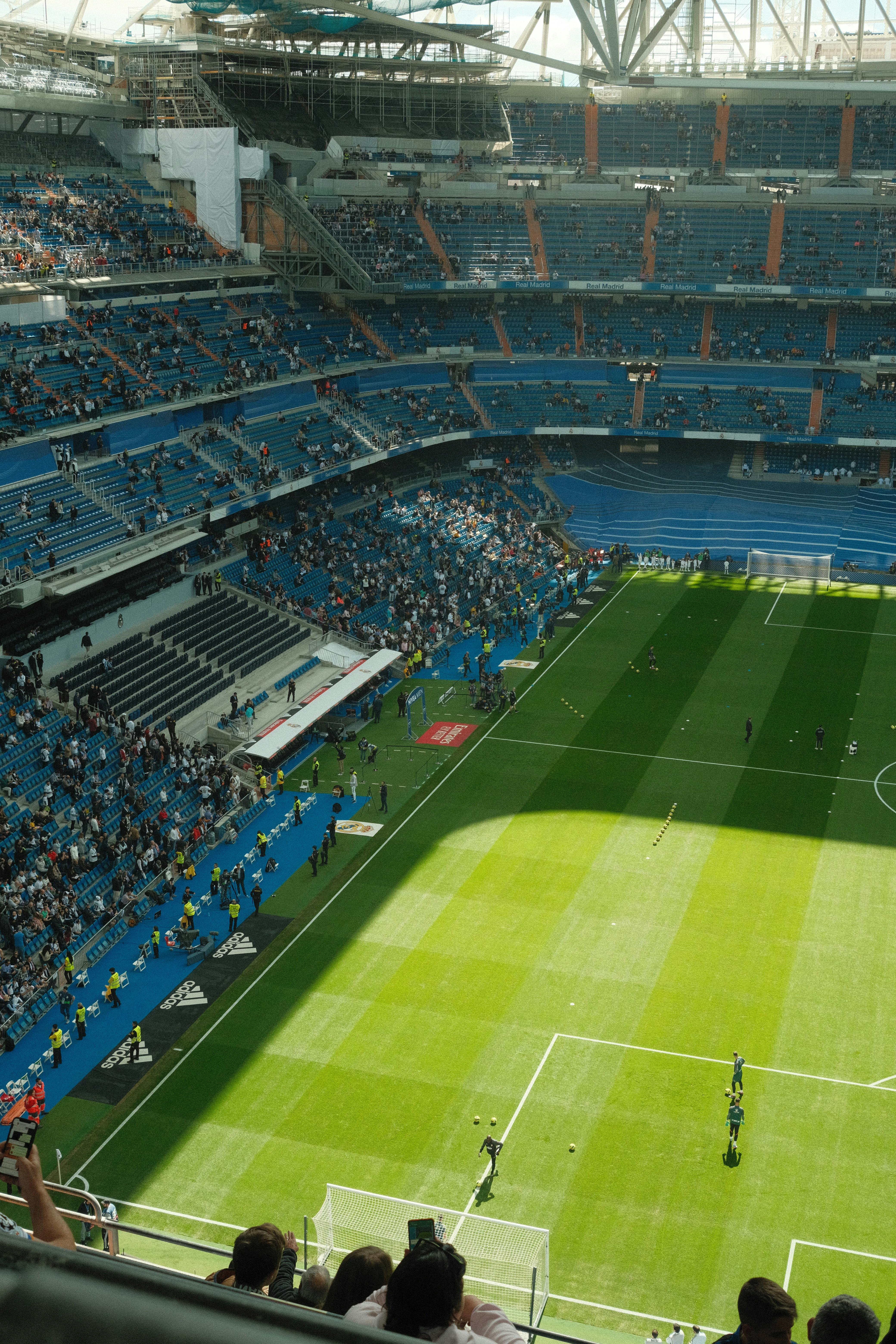 Sunlit Pitch and Stadium Stands in Shadow · Free Stock Photo