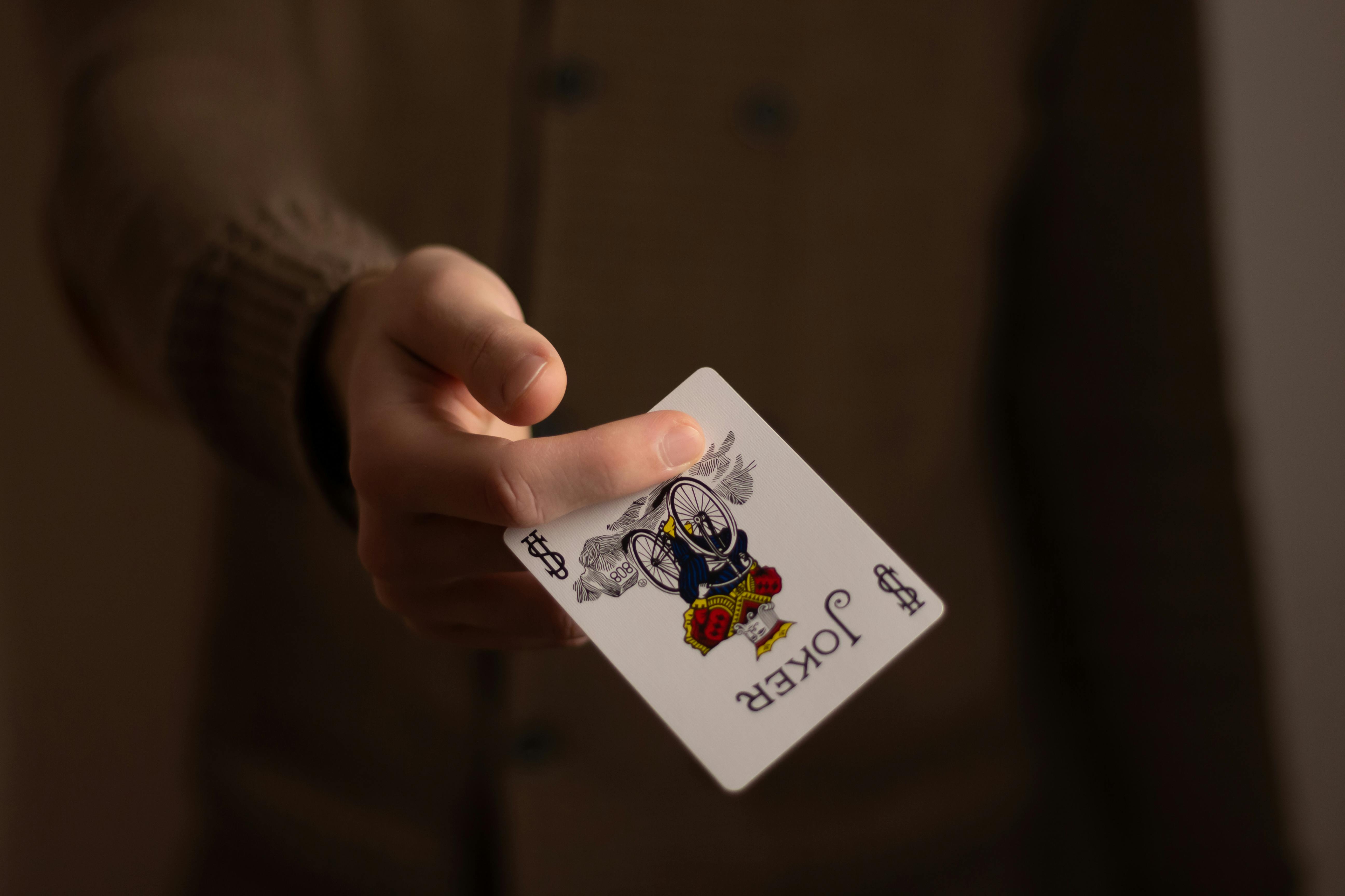 Hand Holding Joker Card · Free Stock Photo