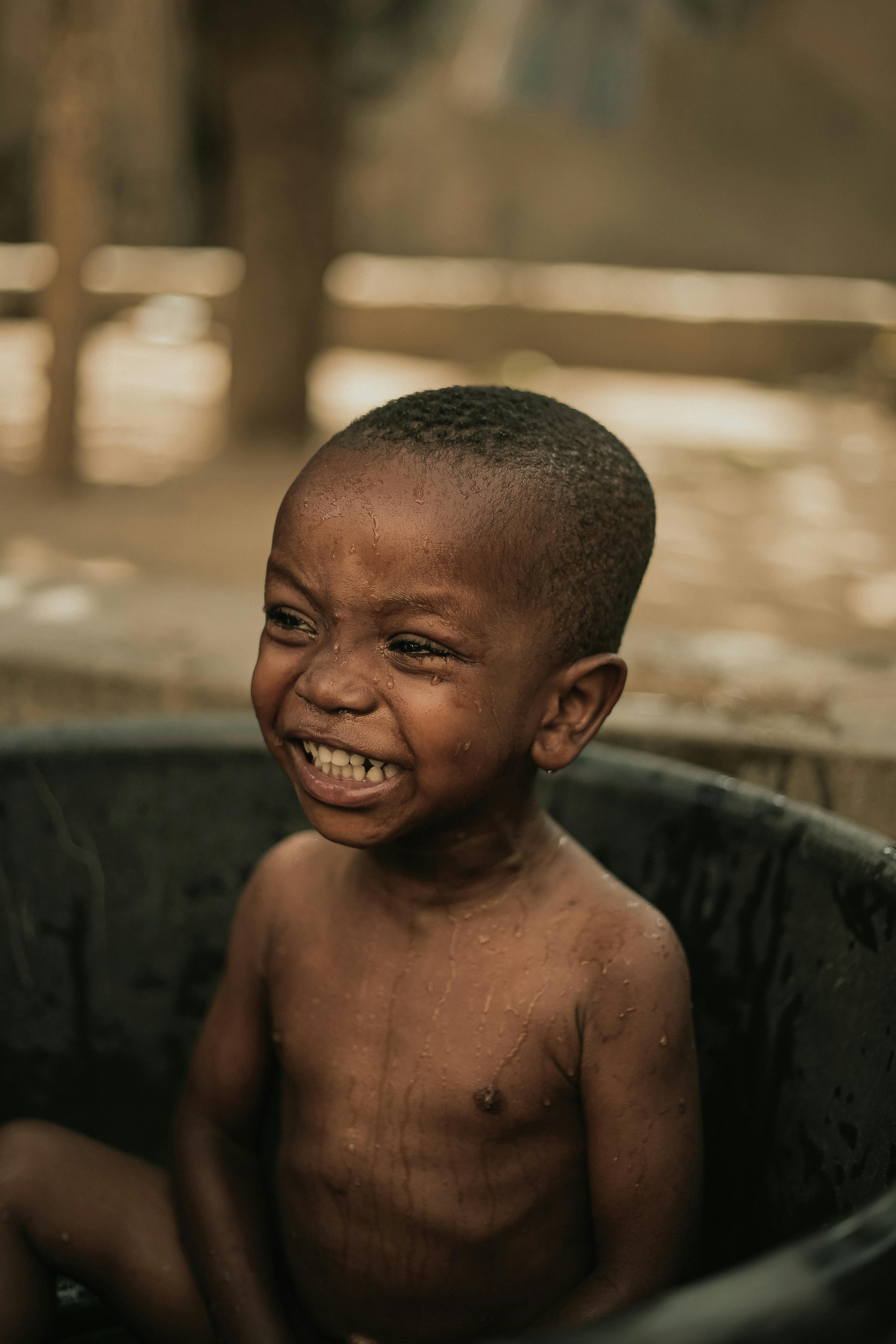 Laughing Boy in a Bucket · Free Stock Photo