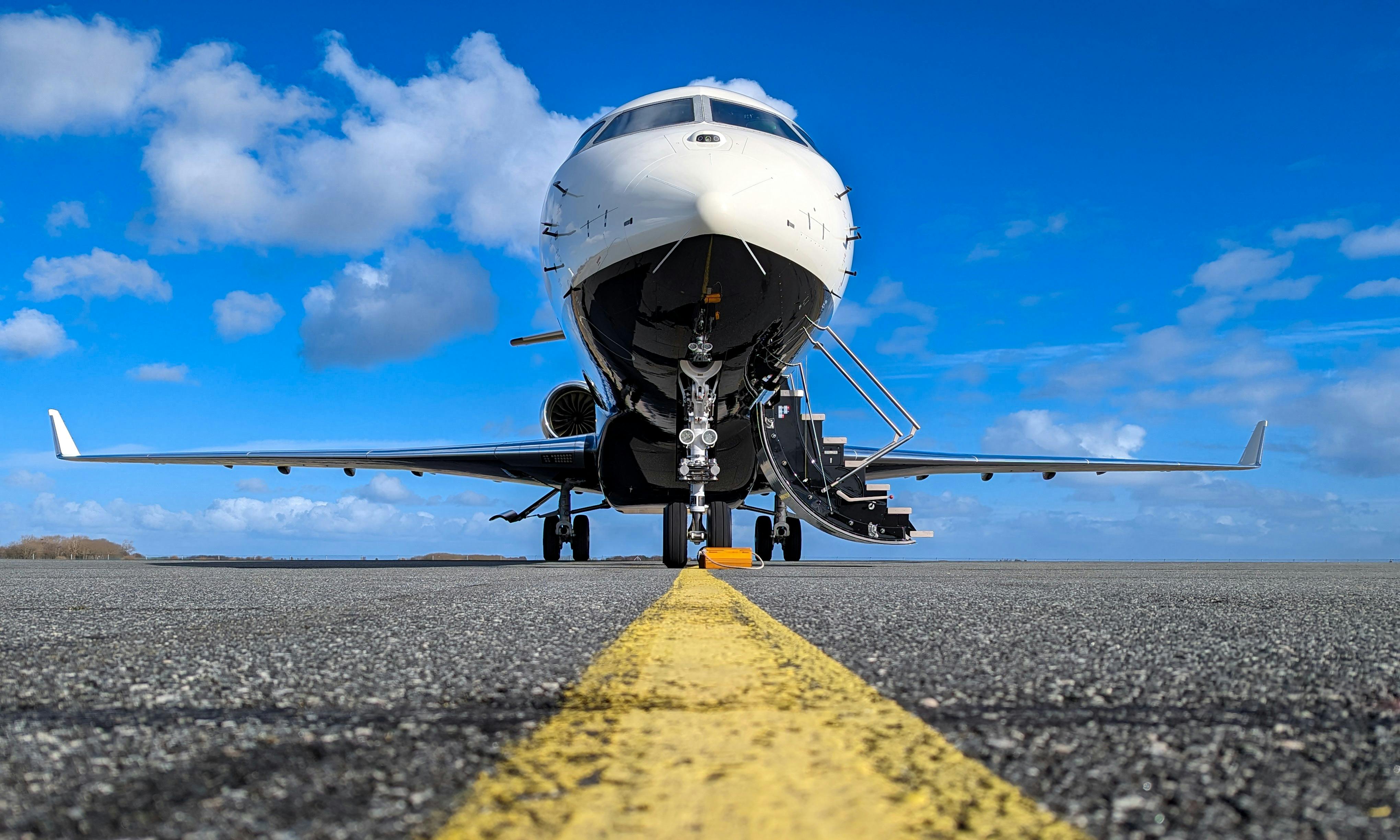 Plane Trail in Blue Sky with Clouds · Free Stock Photo