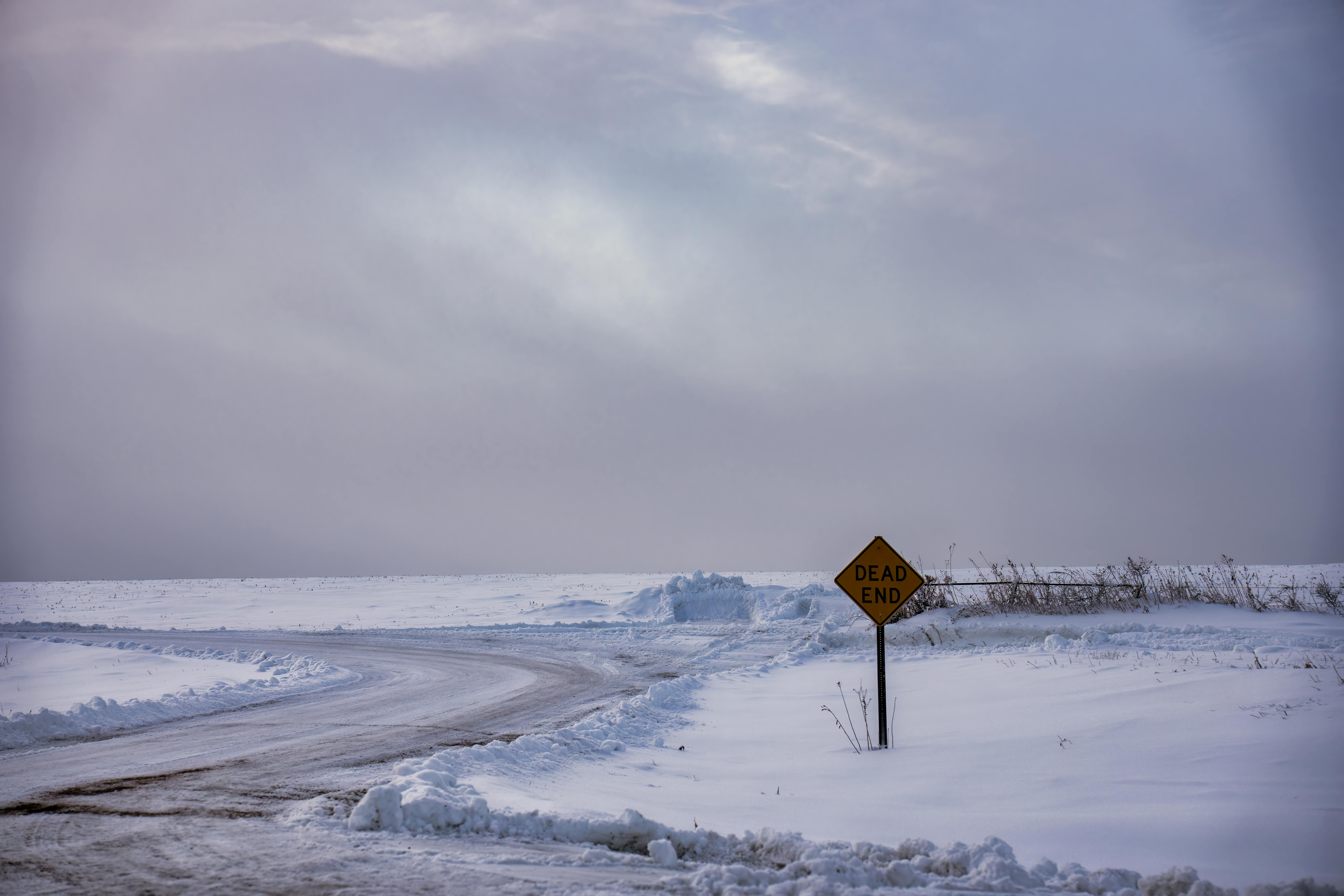 A Road Sign Signalizing a Dead End on a Snowy Field · Free Stock Photo