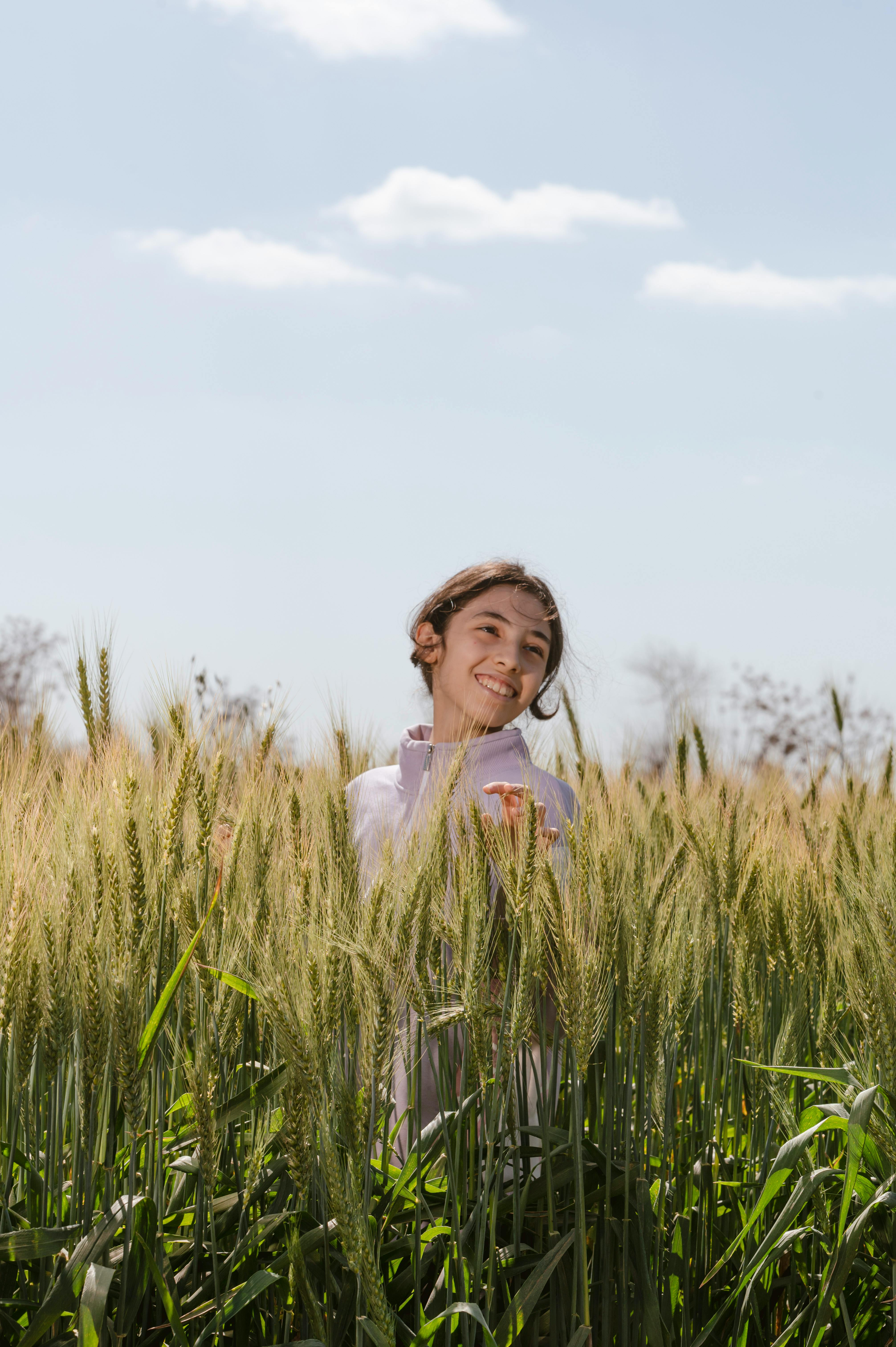 Smiling Girl in Crop Field · Free Stock Photo