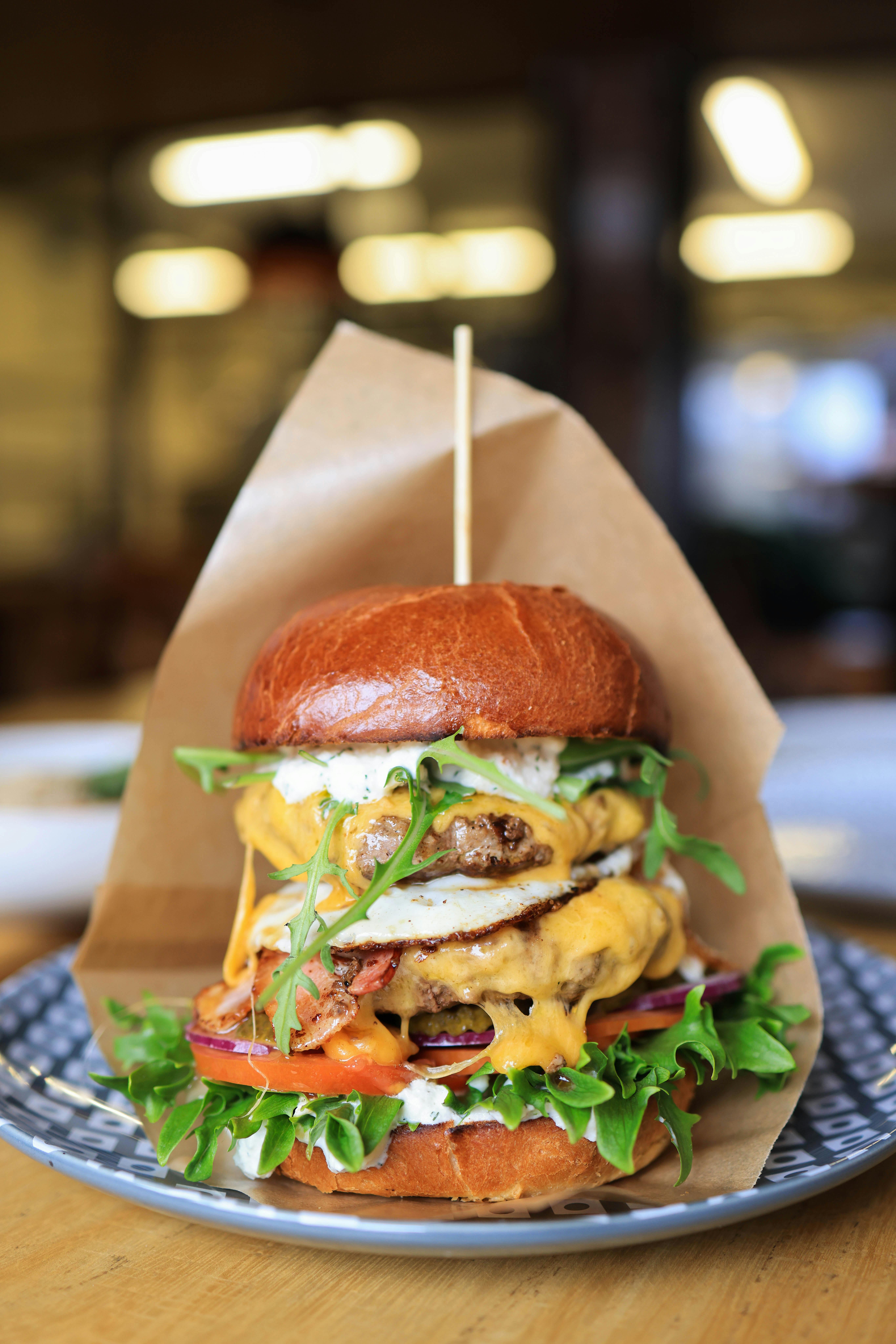 Loaded Burger on Wooden Plate · Free Stock Photo