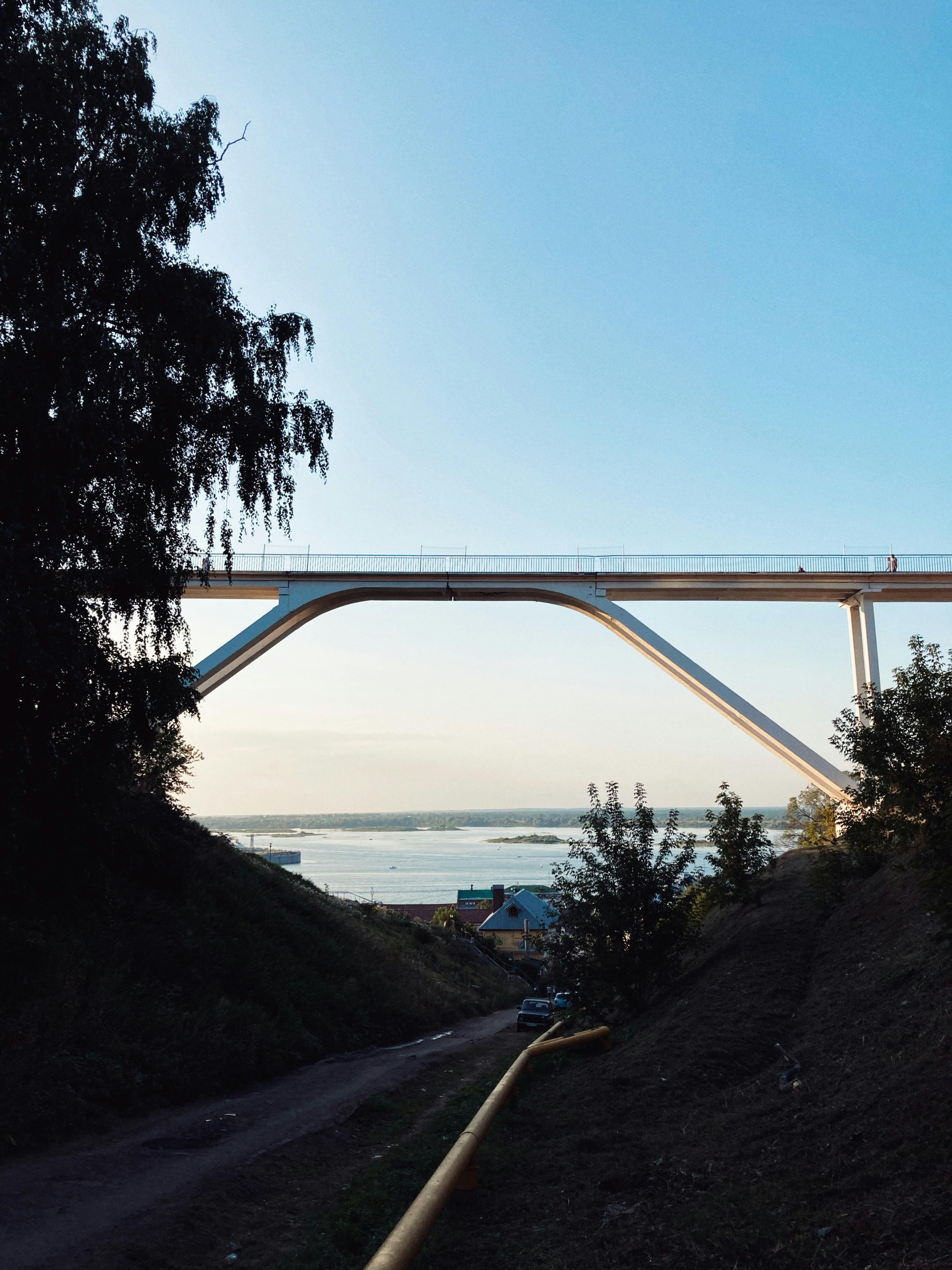 Bridge over a Road and Sea in the Distance · Free Stock Photo