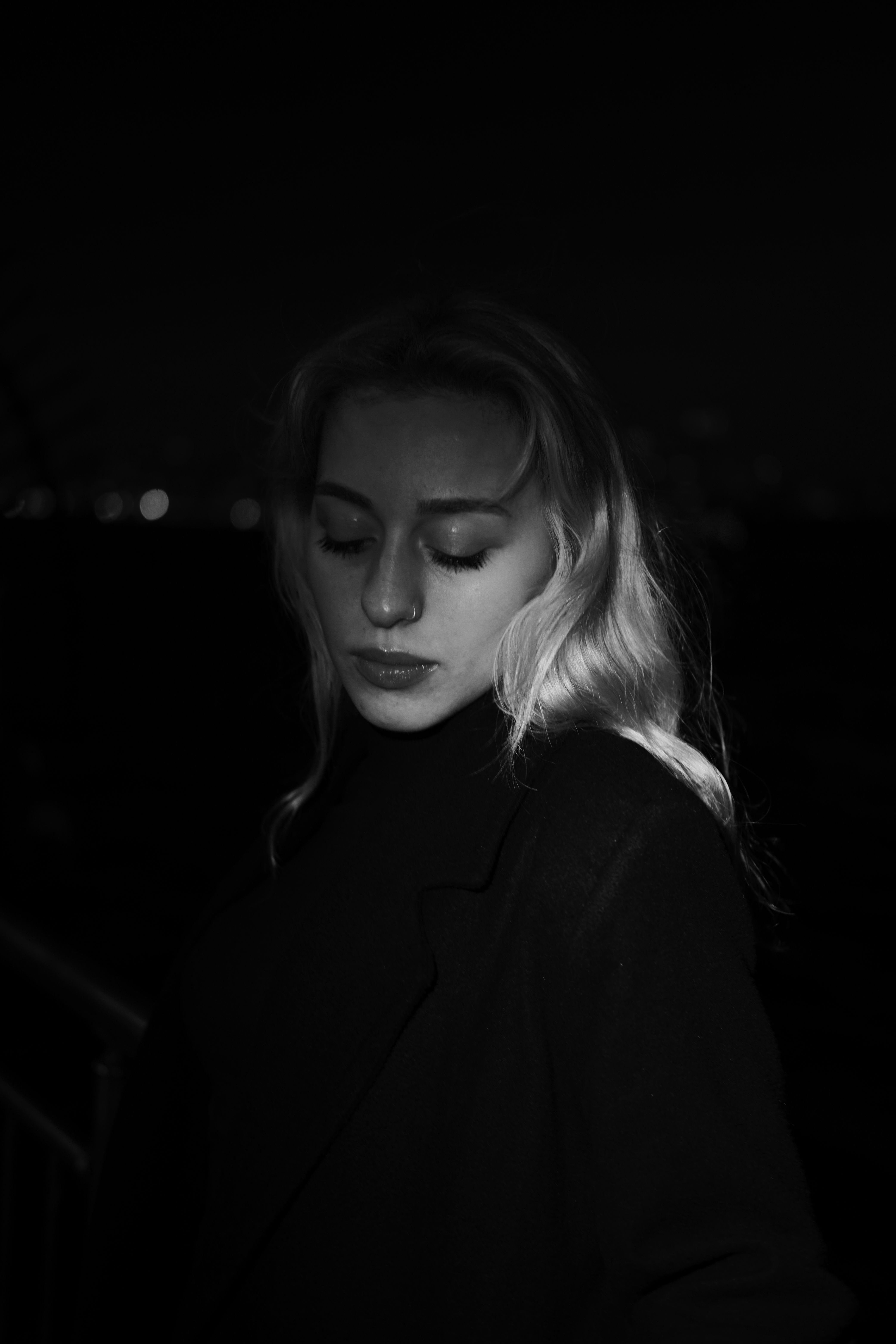 Black and White Photo of a Young Woman Looking Down · Free Stock Photo