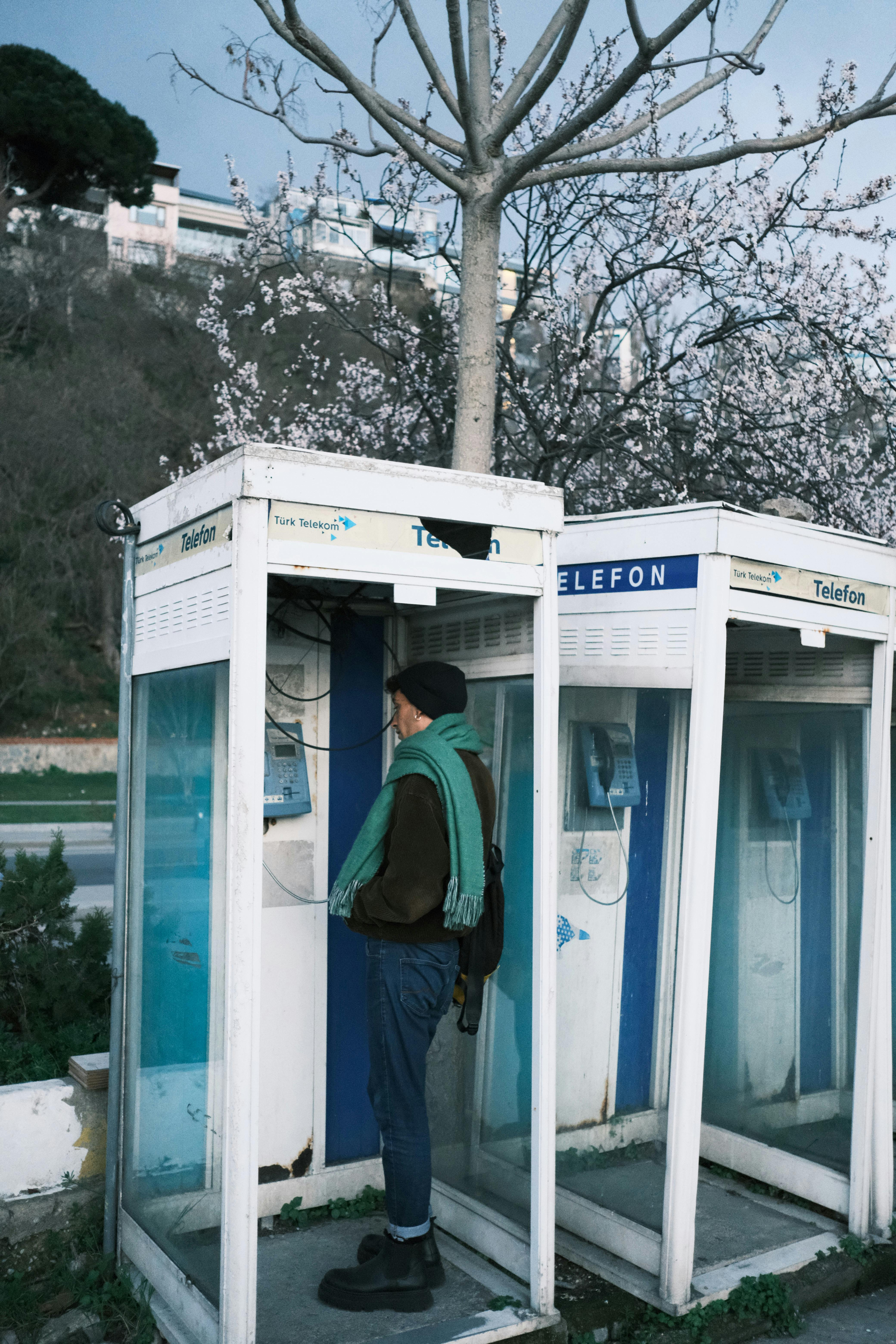 Person Standing in Phone Booths · Free Stock Photo