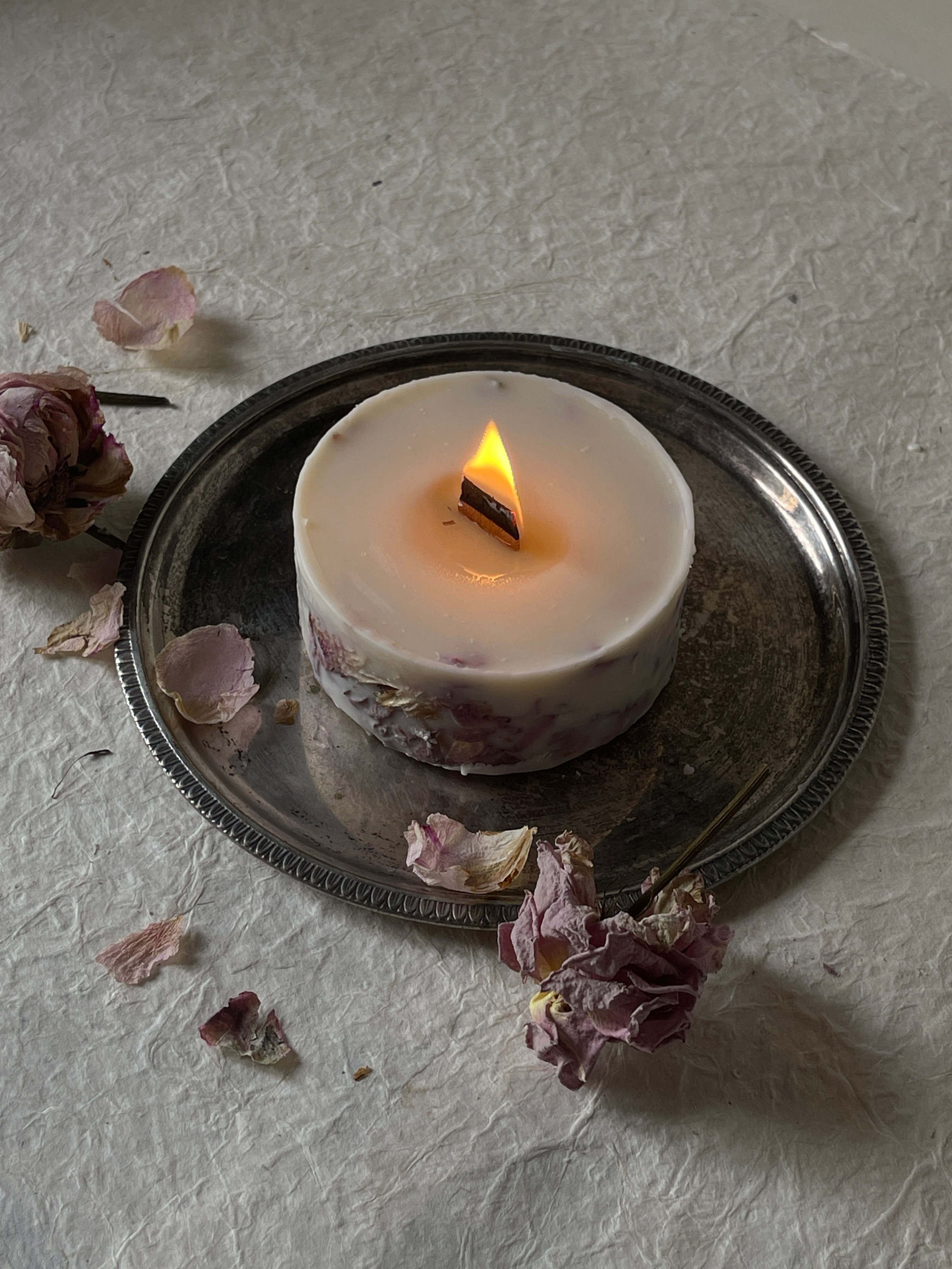 A Burning Candle and Dried Flower Petals · Free Stock Photo