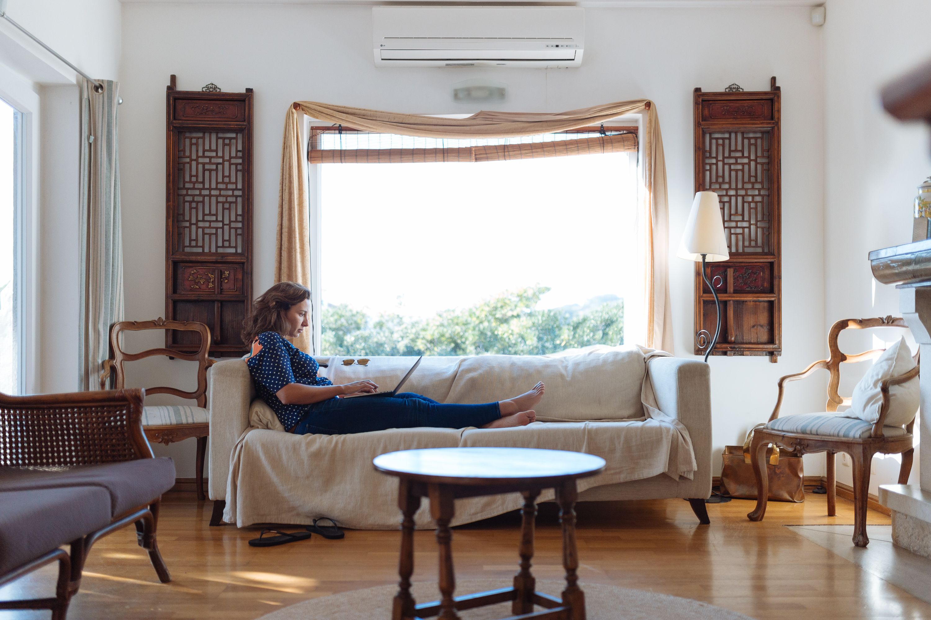 Woman Sitting on Sofa in Living Room · Free Stock Photo