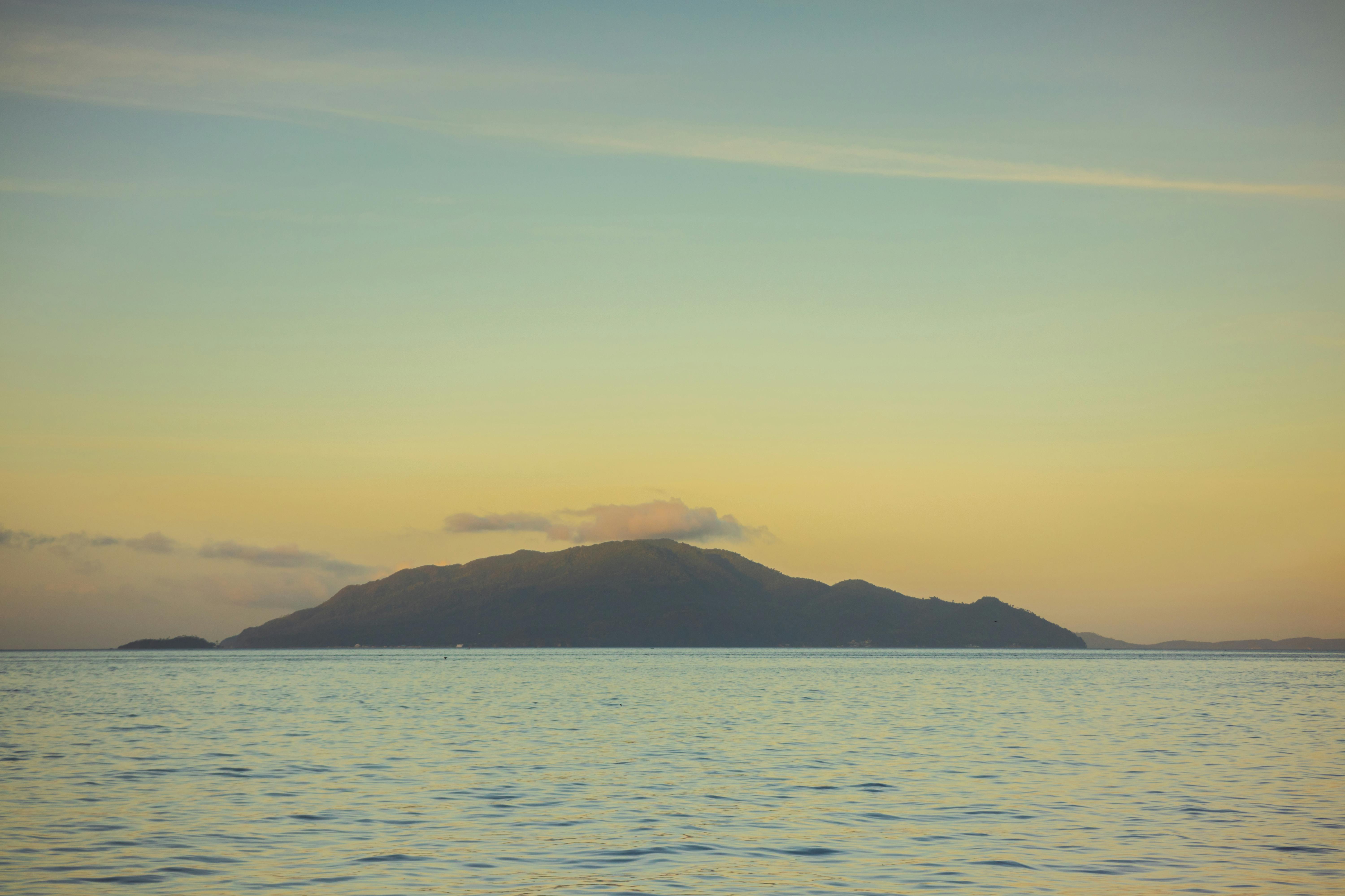 Sun on Yellow Sky over Sea Shore with Islands · Free Stock Photo