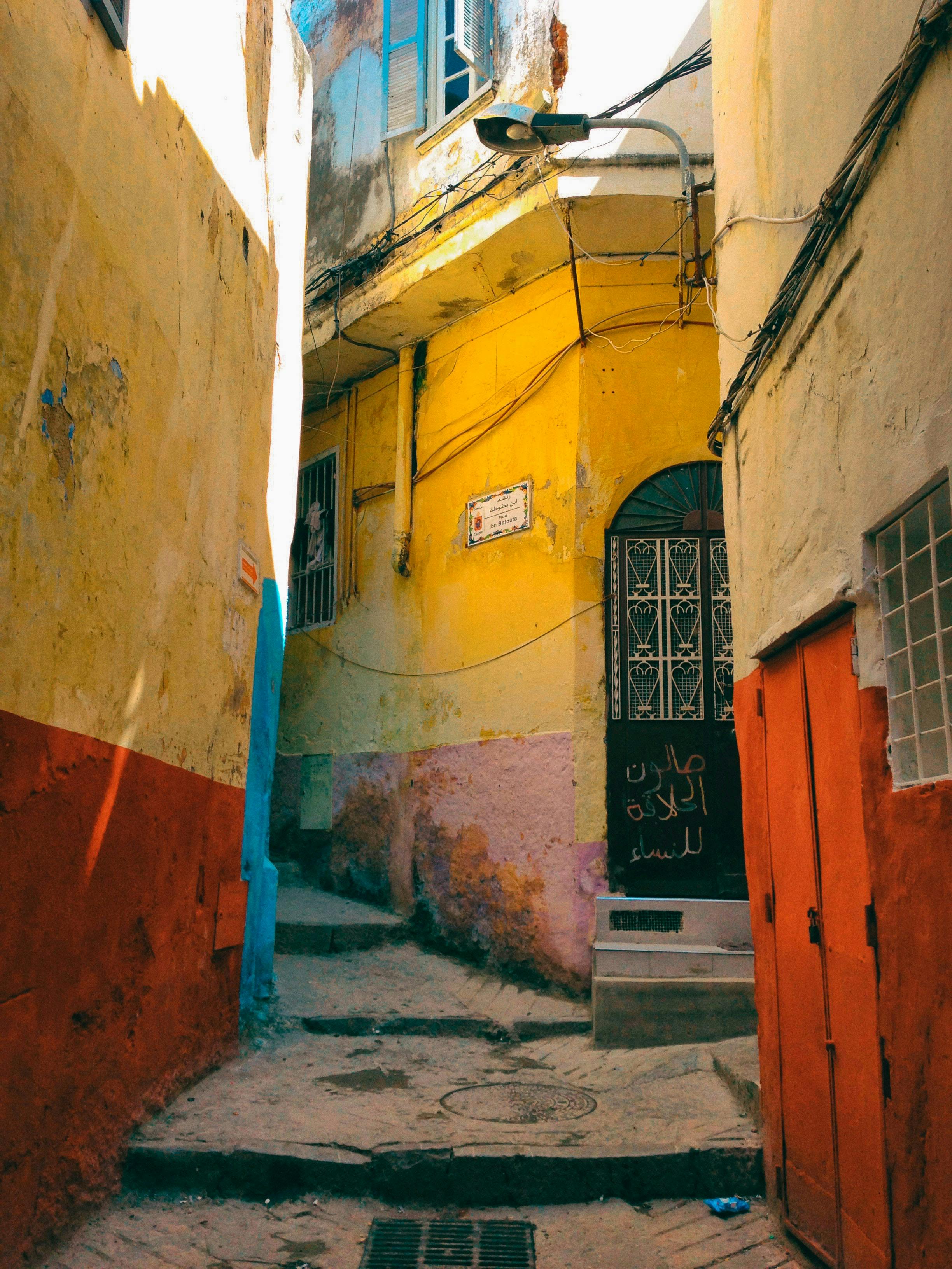 People Walking on Building Alley · Free Stock Photo