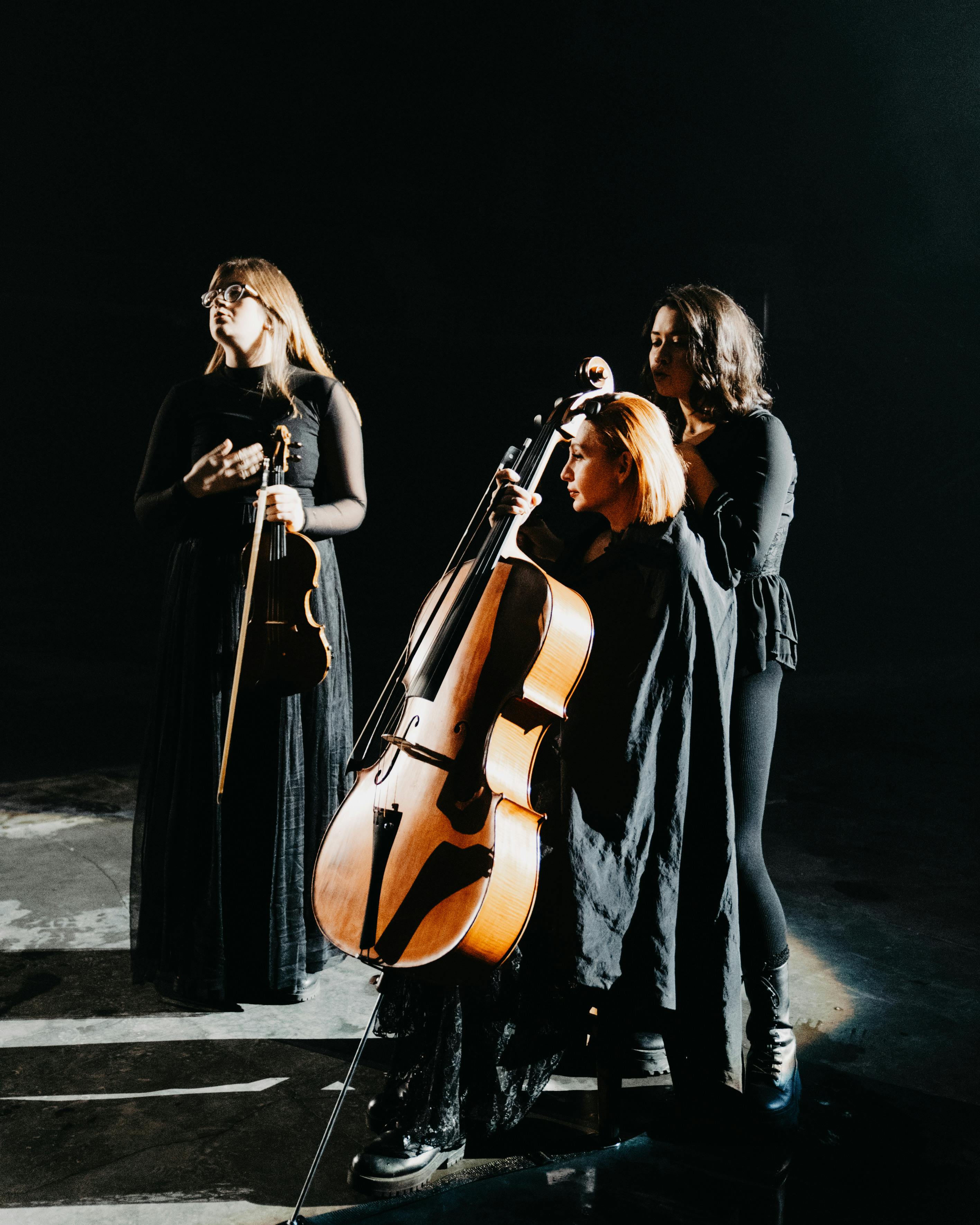 Women in Black Dresses, Playing a Cello and a Violin, Performing on ...