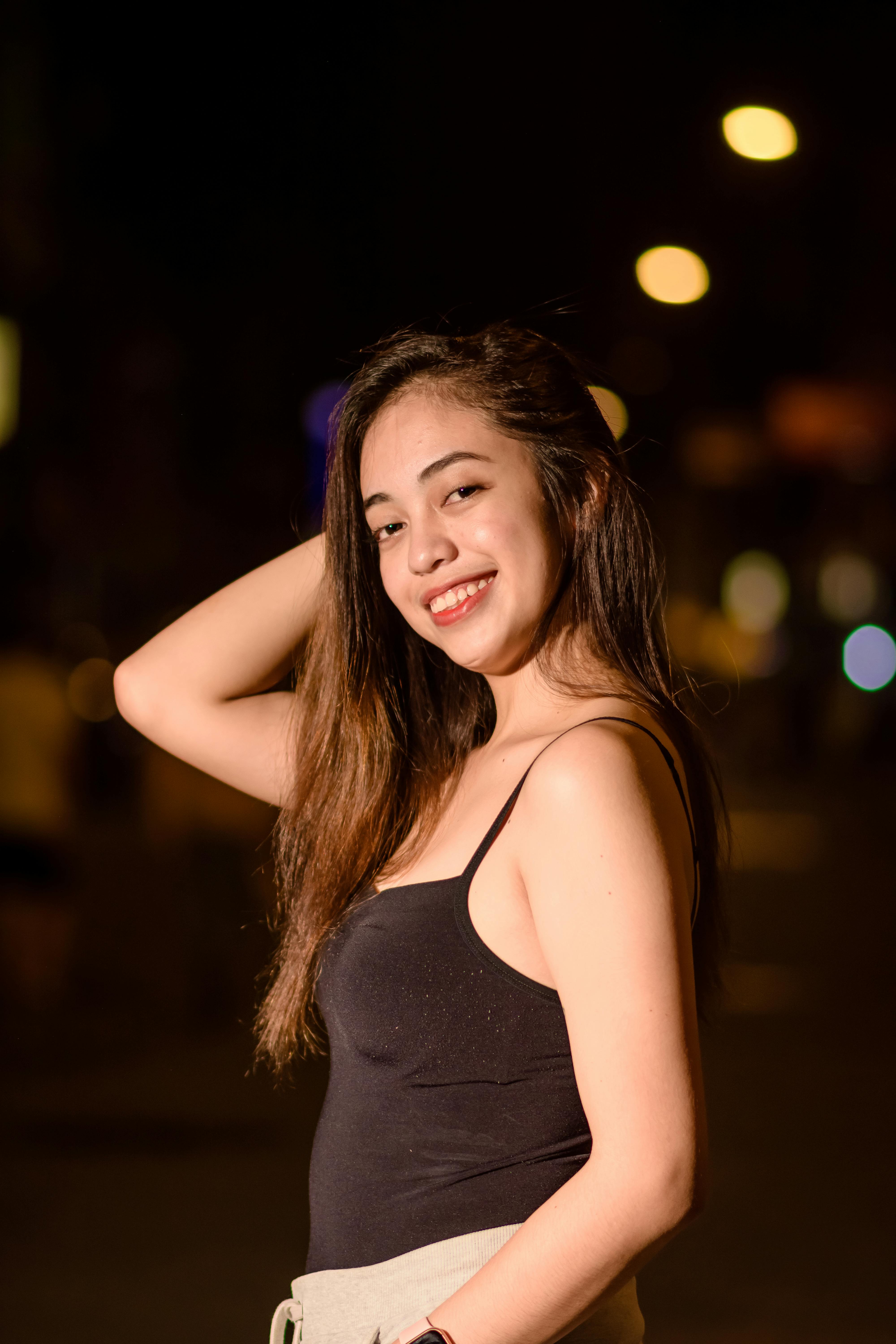 Smiling Woman Posing at Night · Free Stock Photo