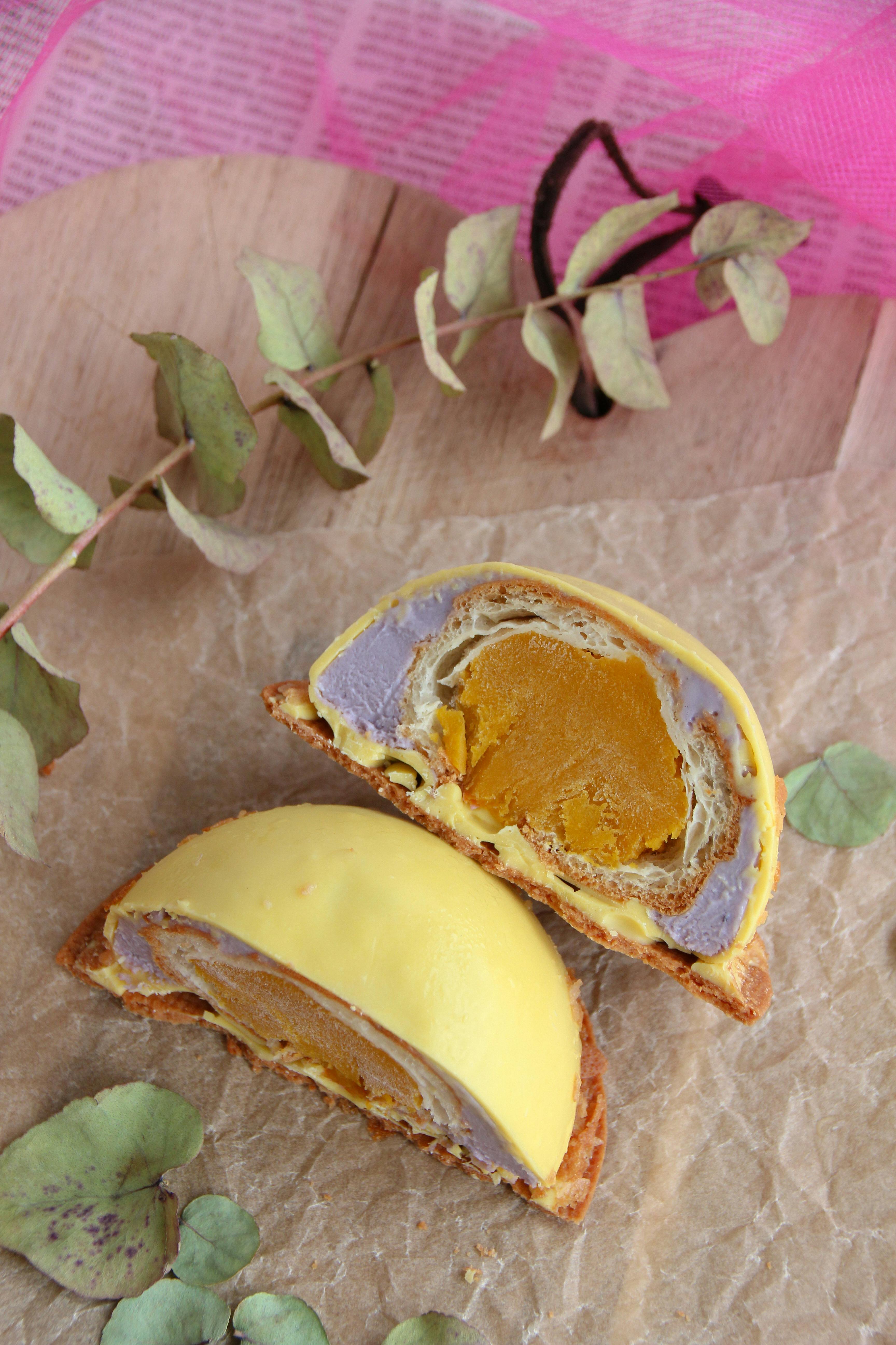 A Small Yellow Cake with Filling Cut in Half · Free Stock Photo