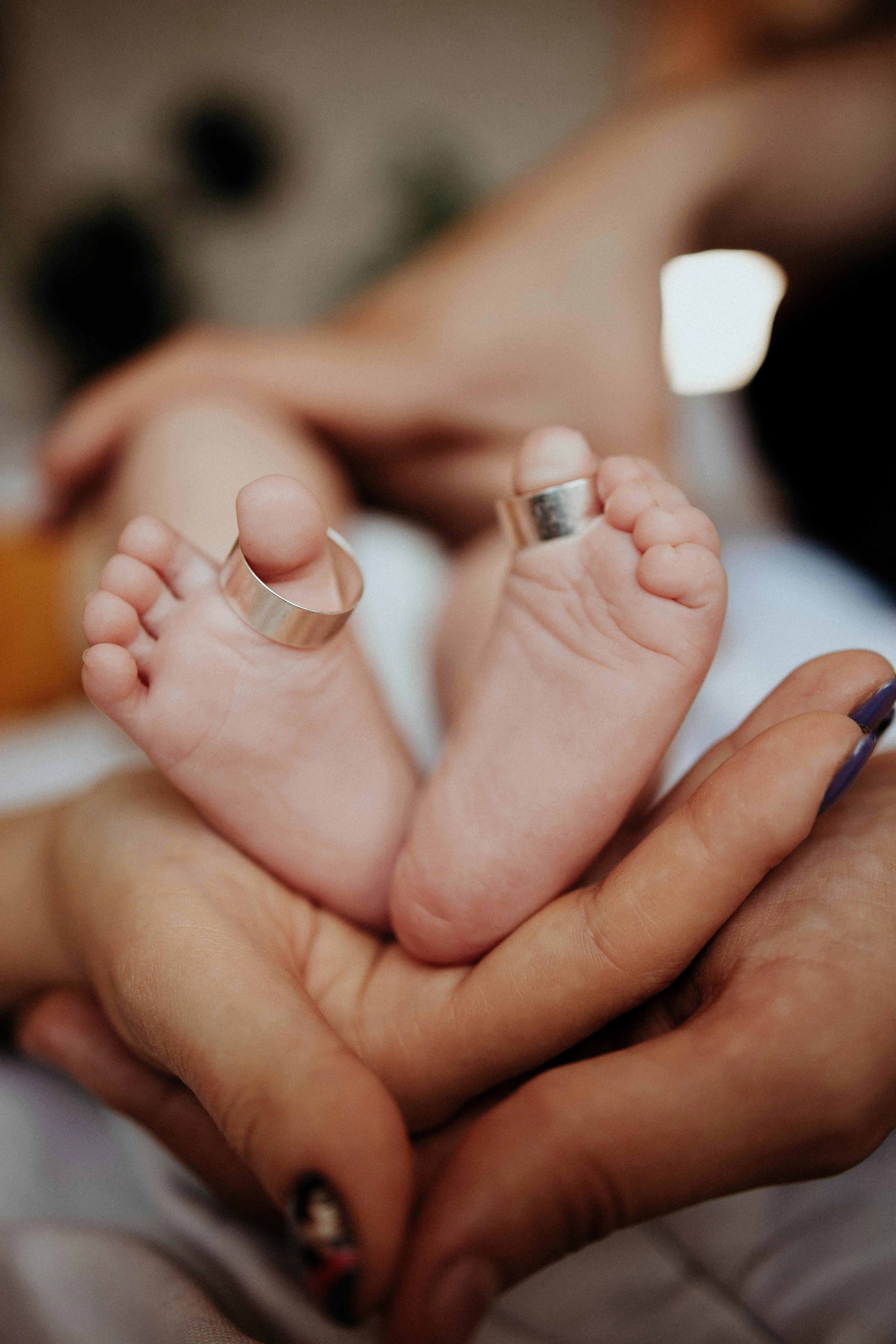 Wedding Rings of the Parents Put on Their Newborn Baby Feet · Free ...