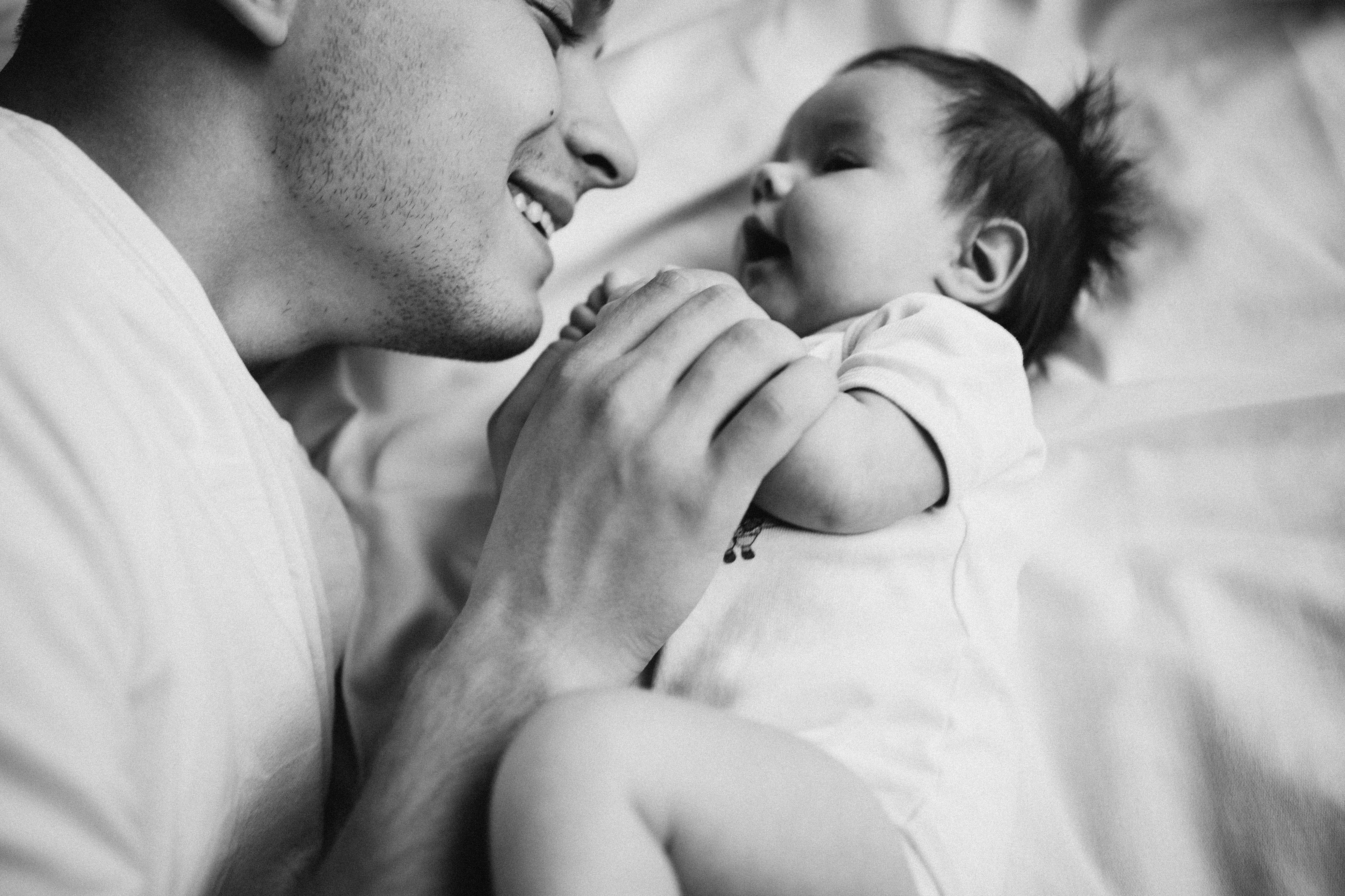 Photo Of Man Carrying Newborn Baby · Free Stock Photo