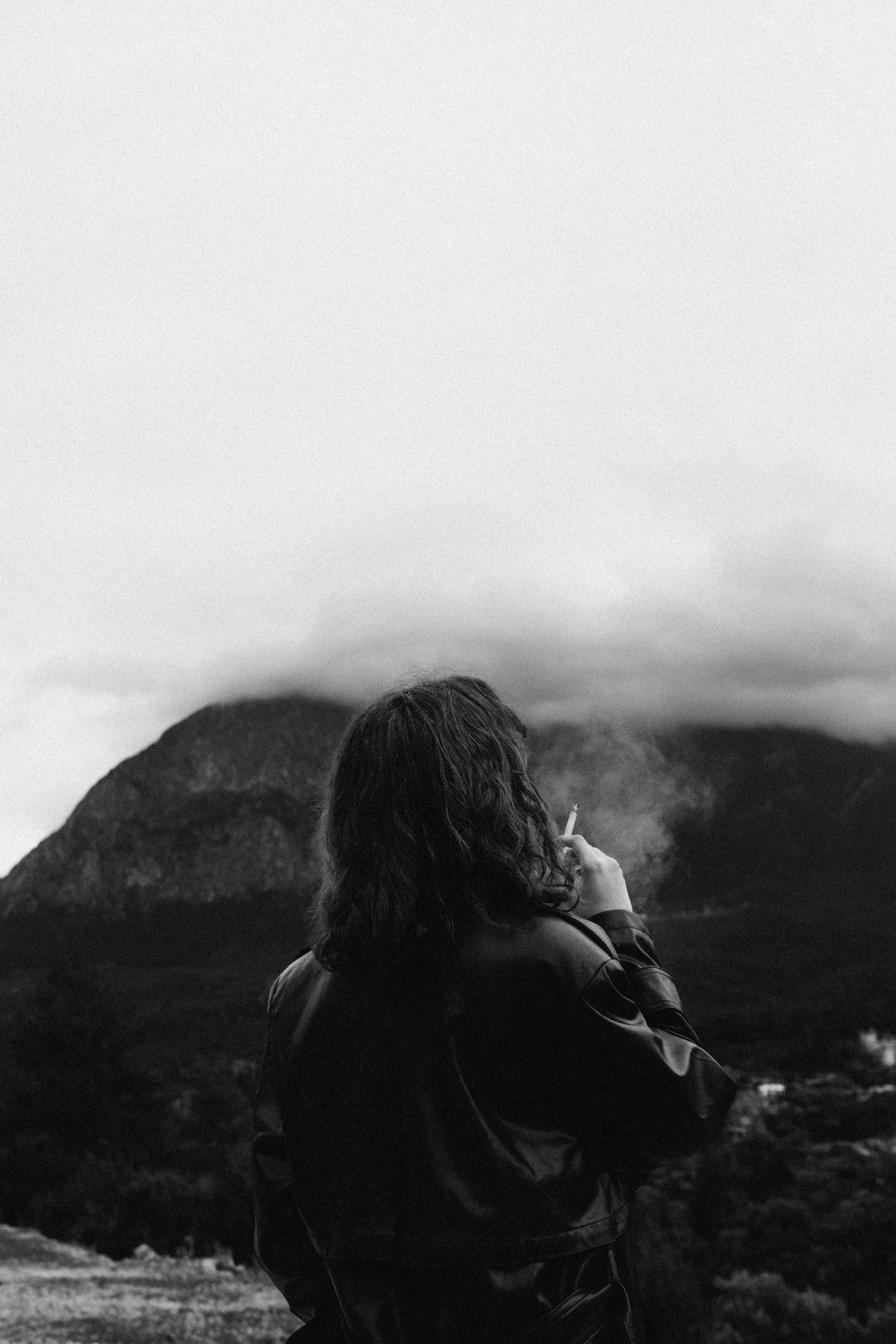 Back View of Woman Smoking a Cigarette and Looking at Mountains · Free ...