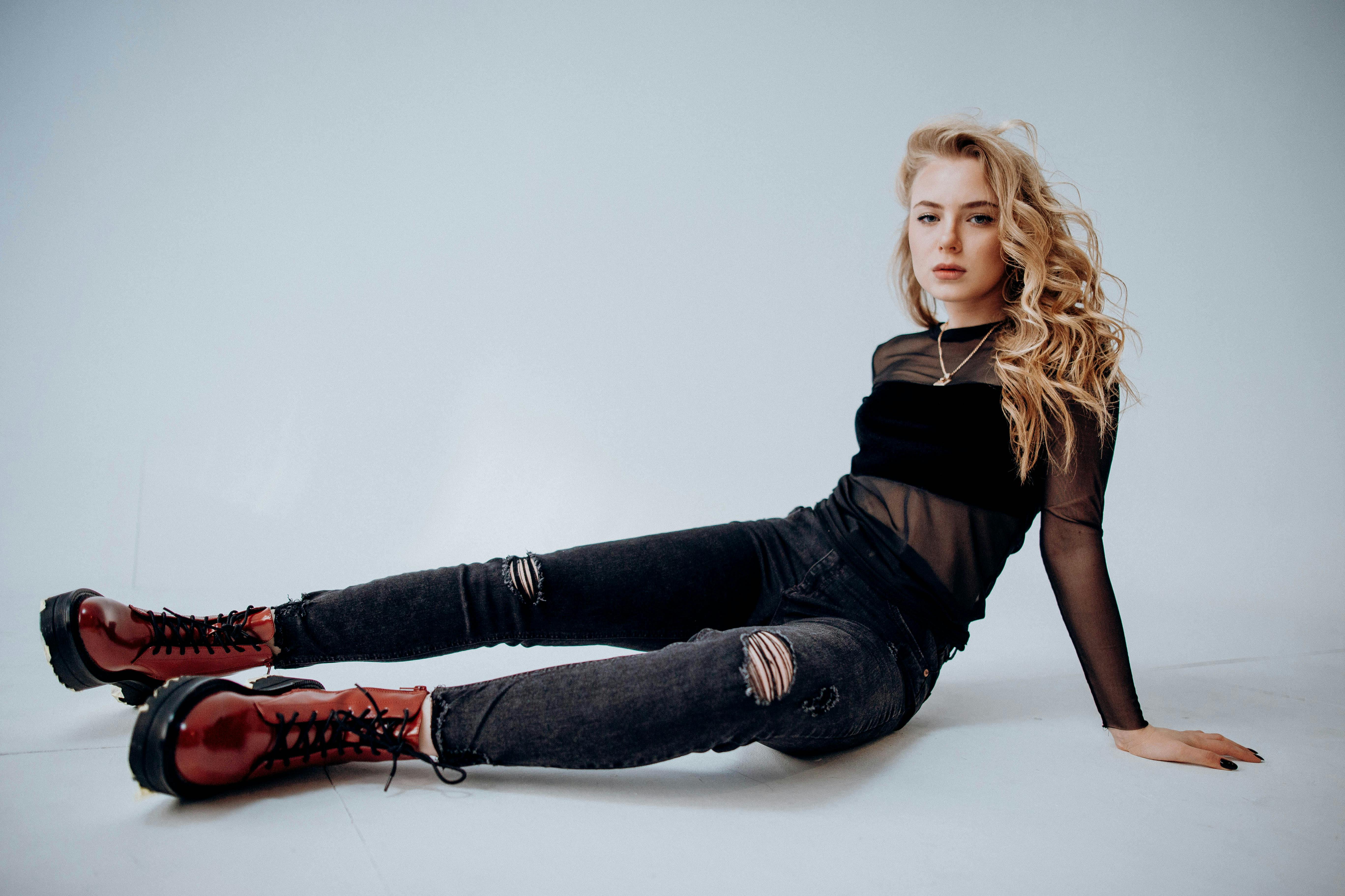 Blonde Woman Sitting and Posing · Free Stock Photo