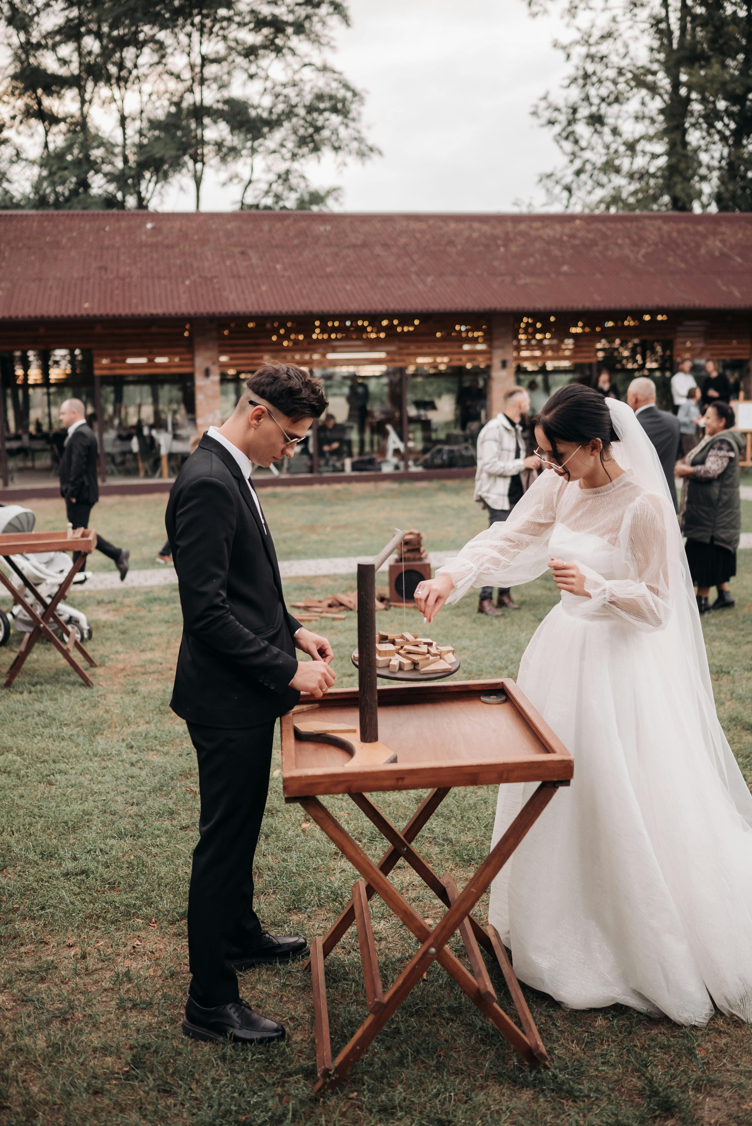 Bride and Groom Playing a Game at the Wedding Reception · Free Stock Photo