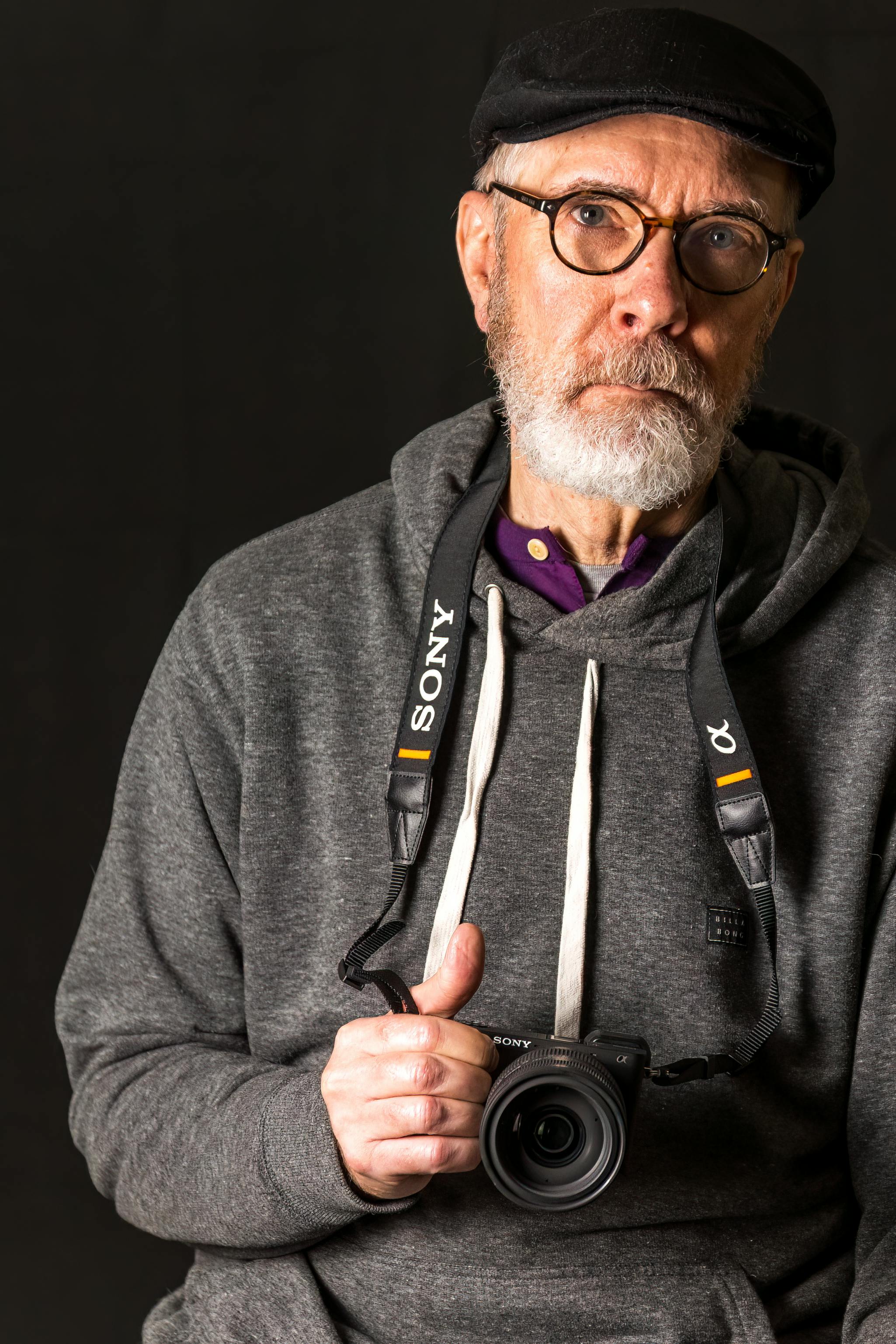 Grayscale Portrait Photo of Man Wearing Holding a Camera · Free Stock Photo