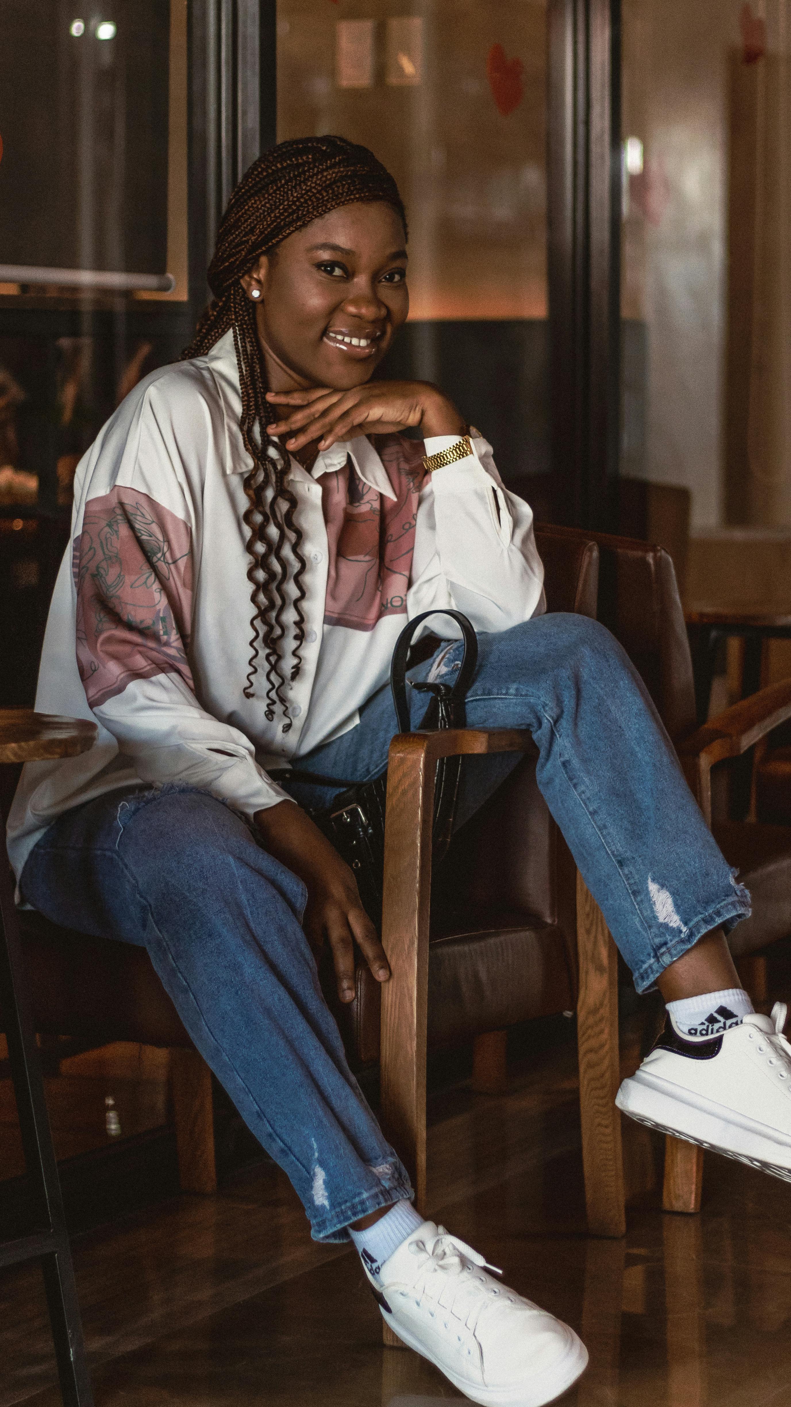 Portrait of Curly Haired Woman in Jeans Crouching · Free Stock Photo