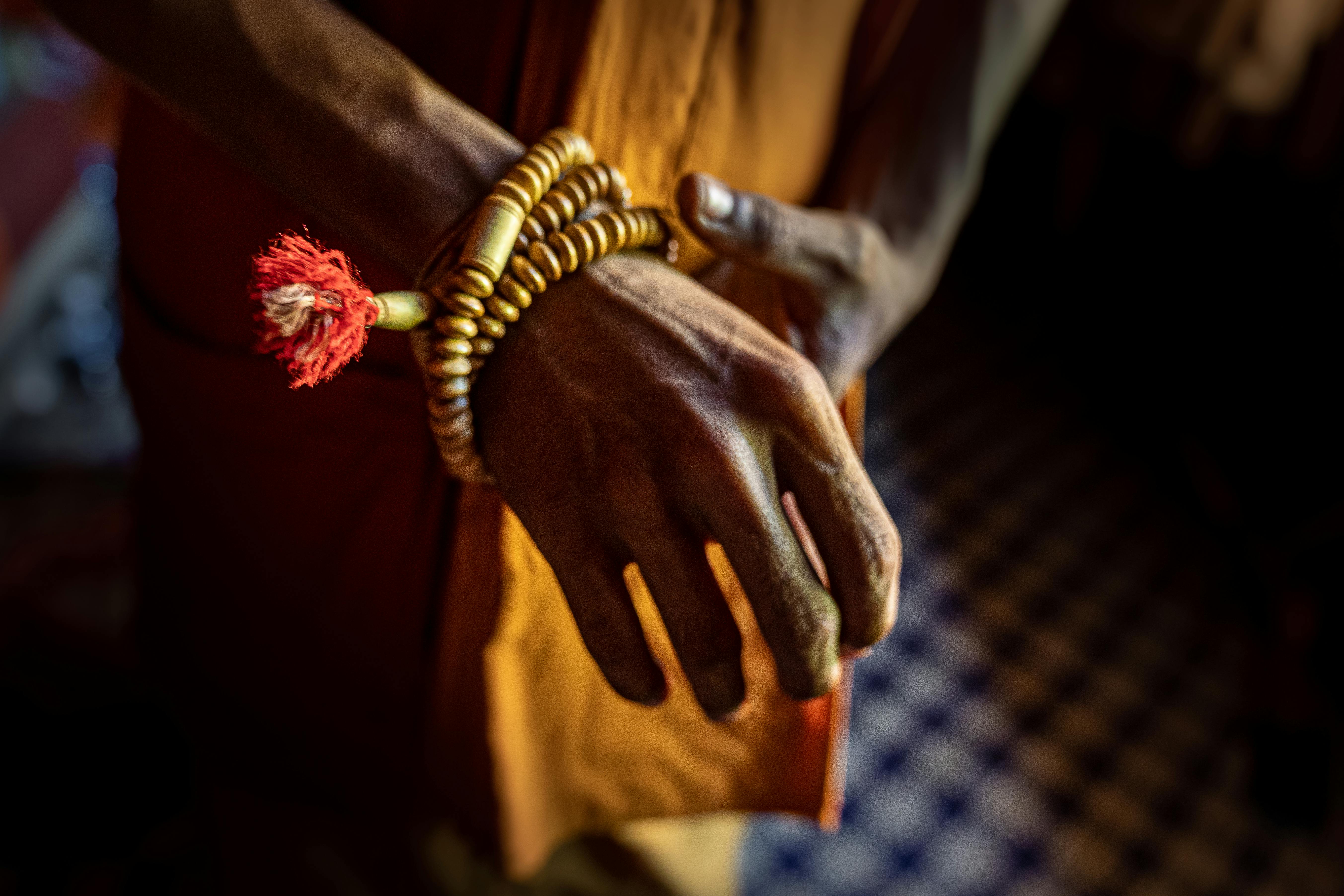 Bracelet on Monk Hand · Free Stock Photo