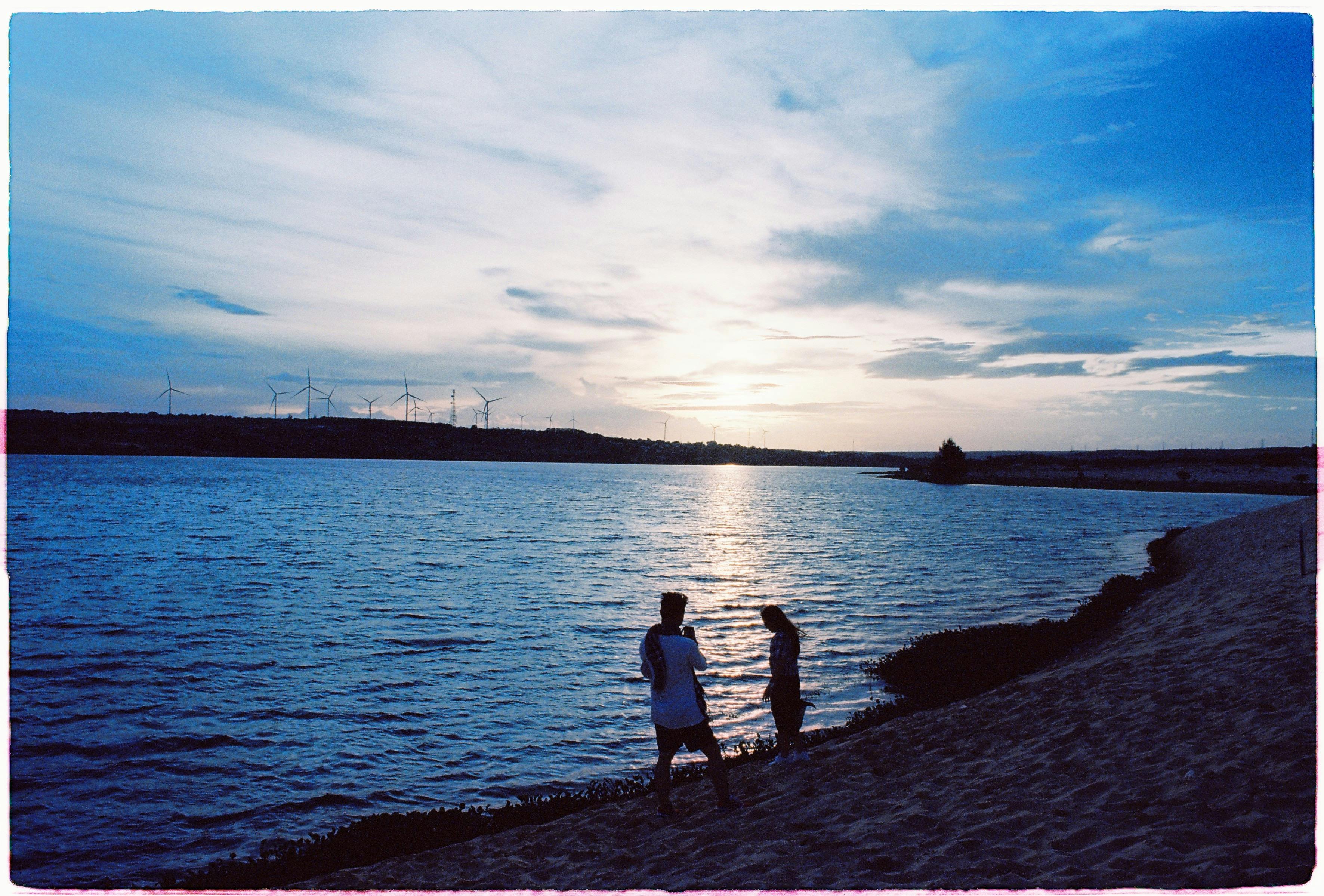 Man and Woman Standing near Water · Free Stock Photo