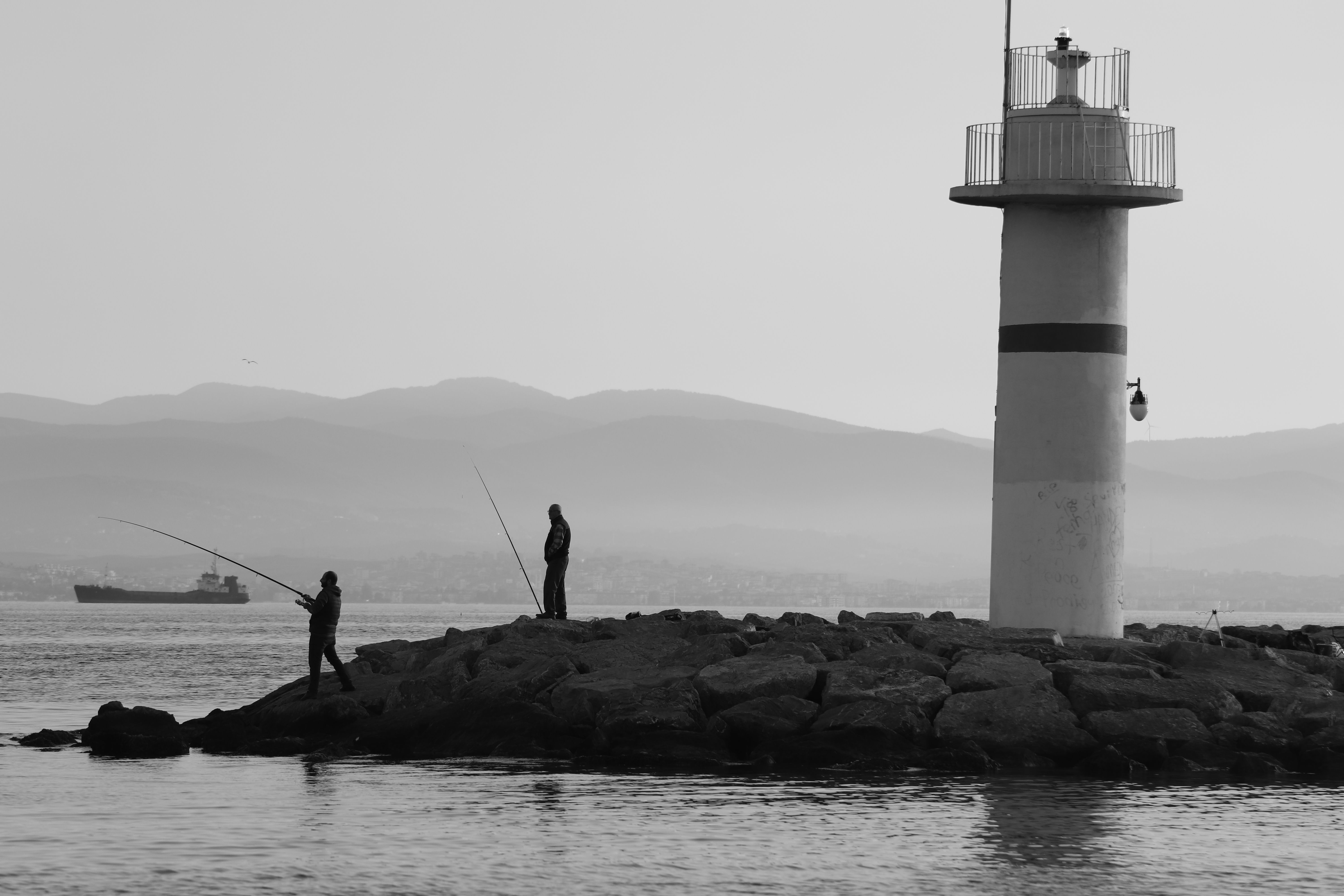 Fishermen near Lighthouse · Free Stock Photo