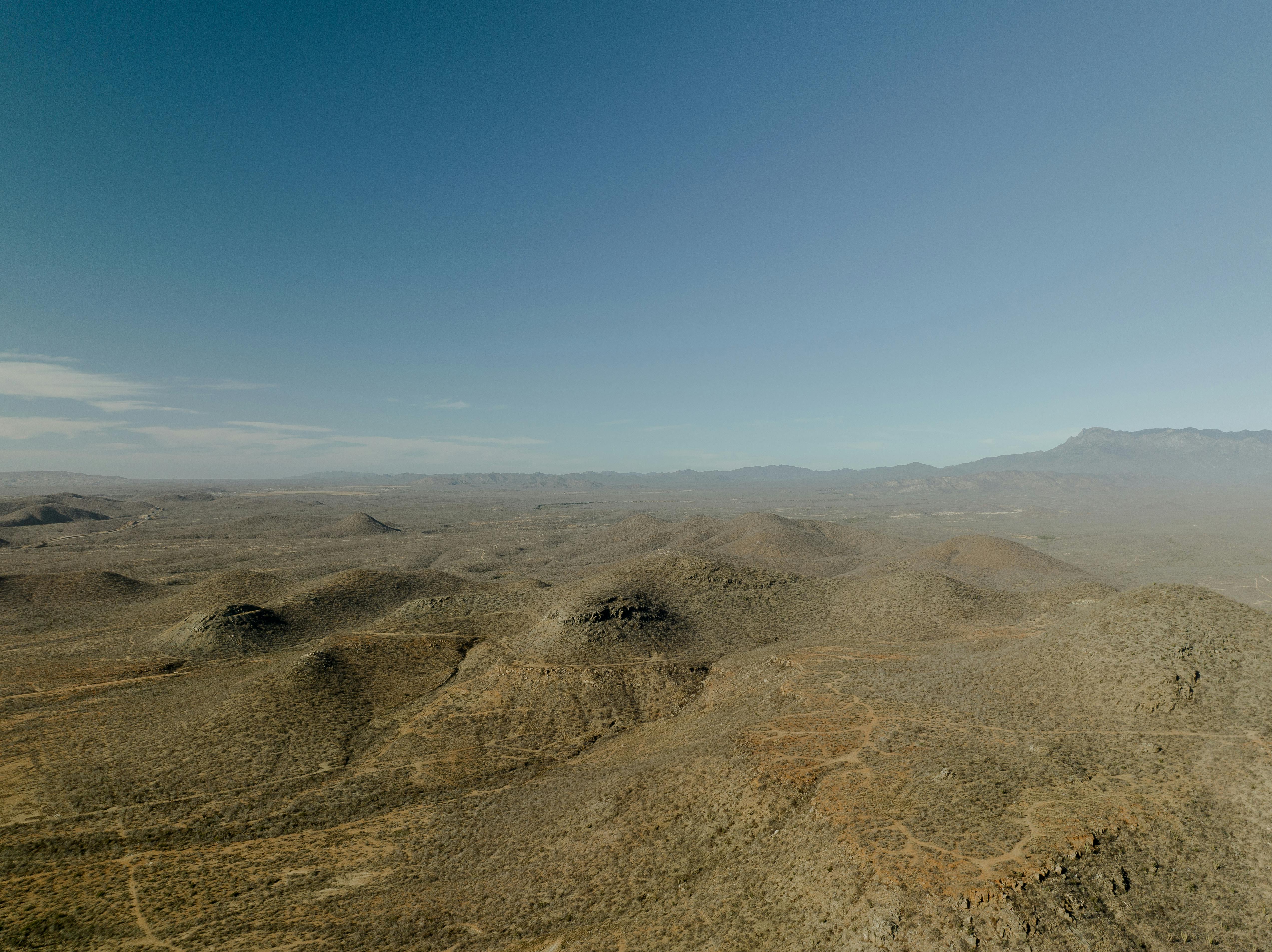 Aerial View of a Desert with Hills under Clear, Blue Sky · Free Stock Photo