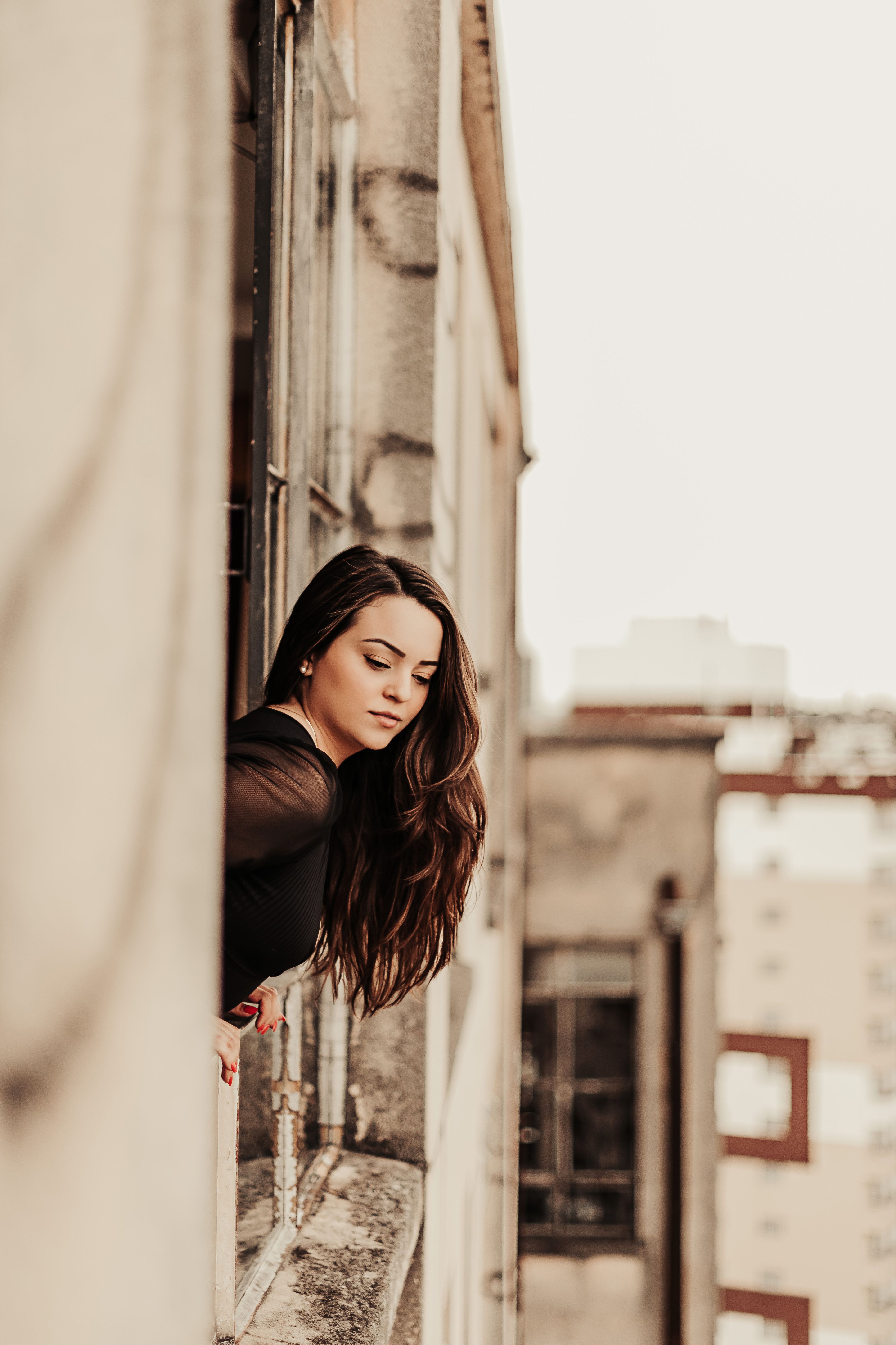 Woman Leaning Out of Window · Free Stock Photo